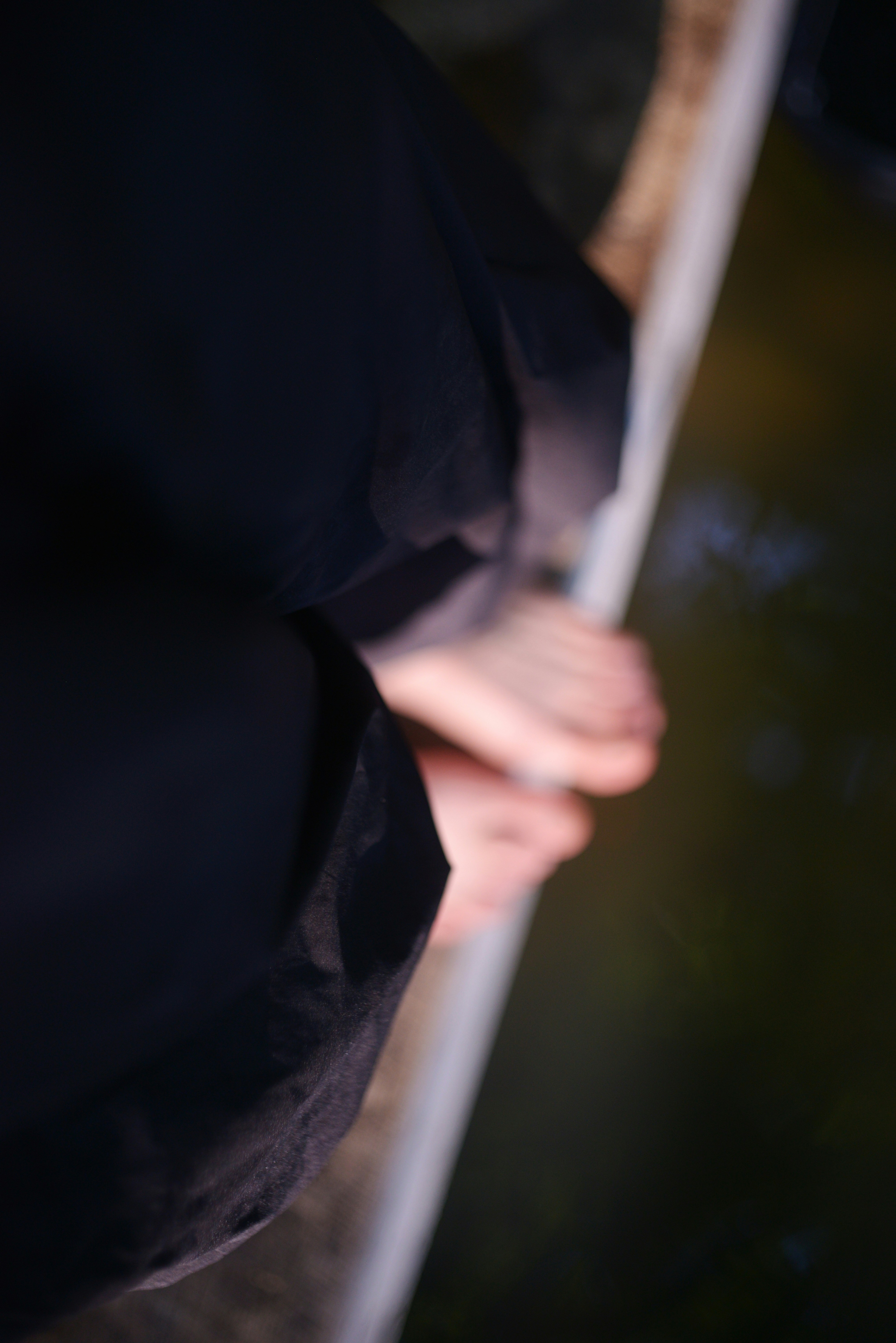 Riverside Vigil: Hands Grasp a Calm Oar