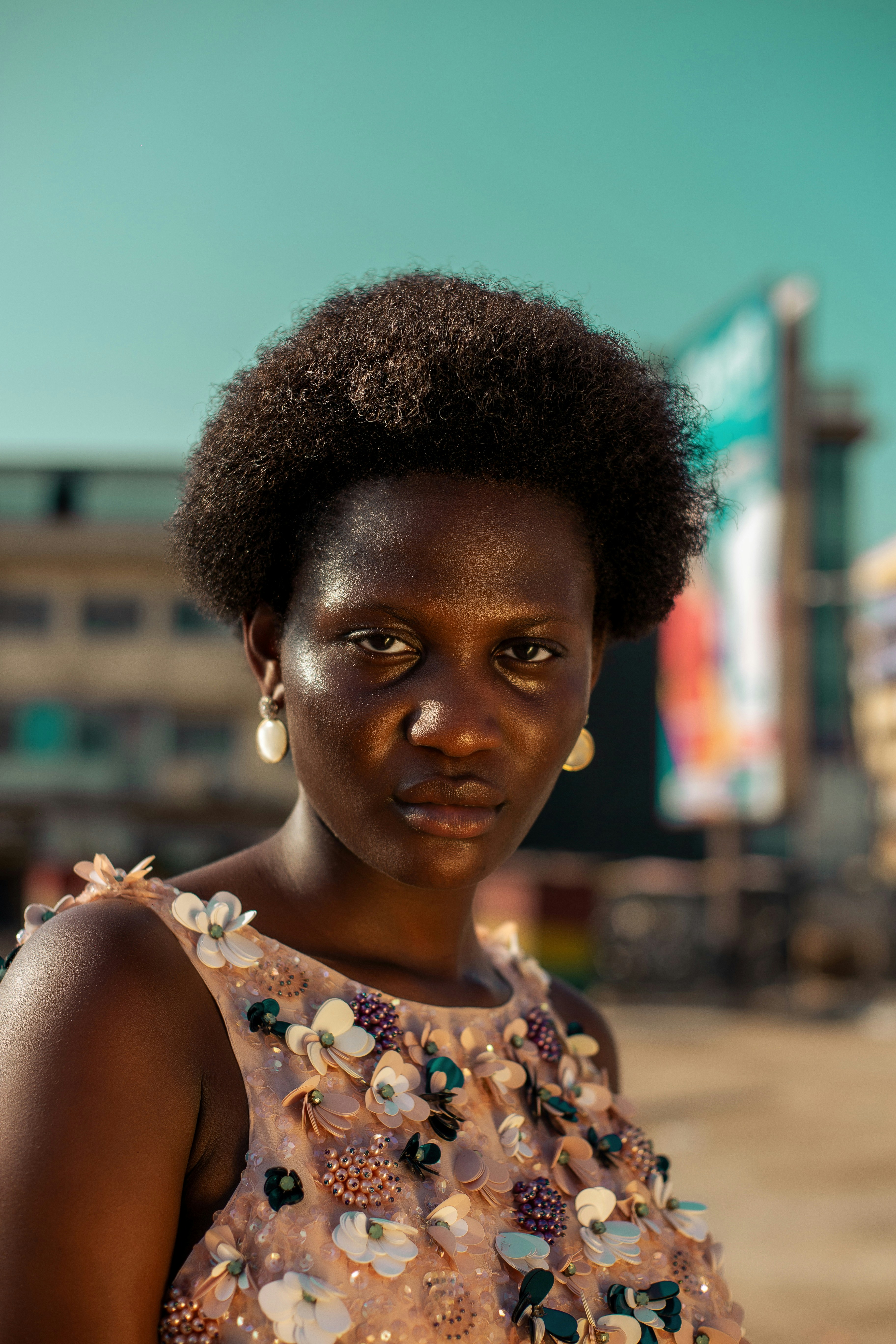 Portrait in Warm Sun: A Close-up Against Urban Twilight