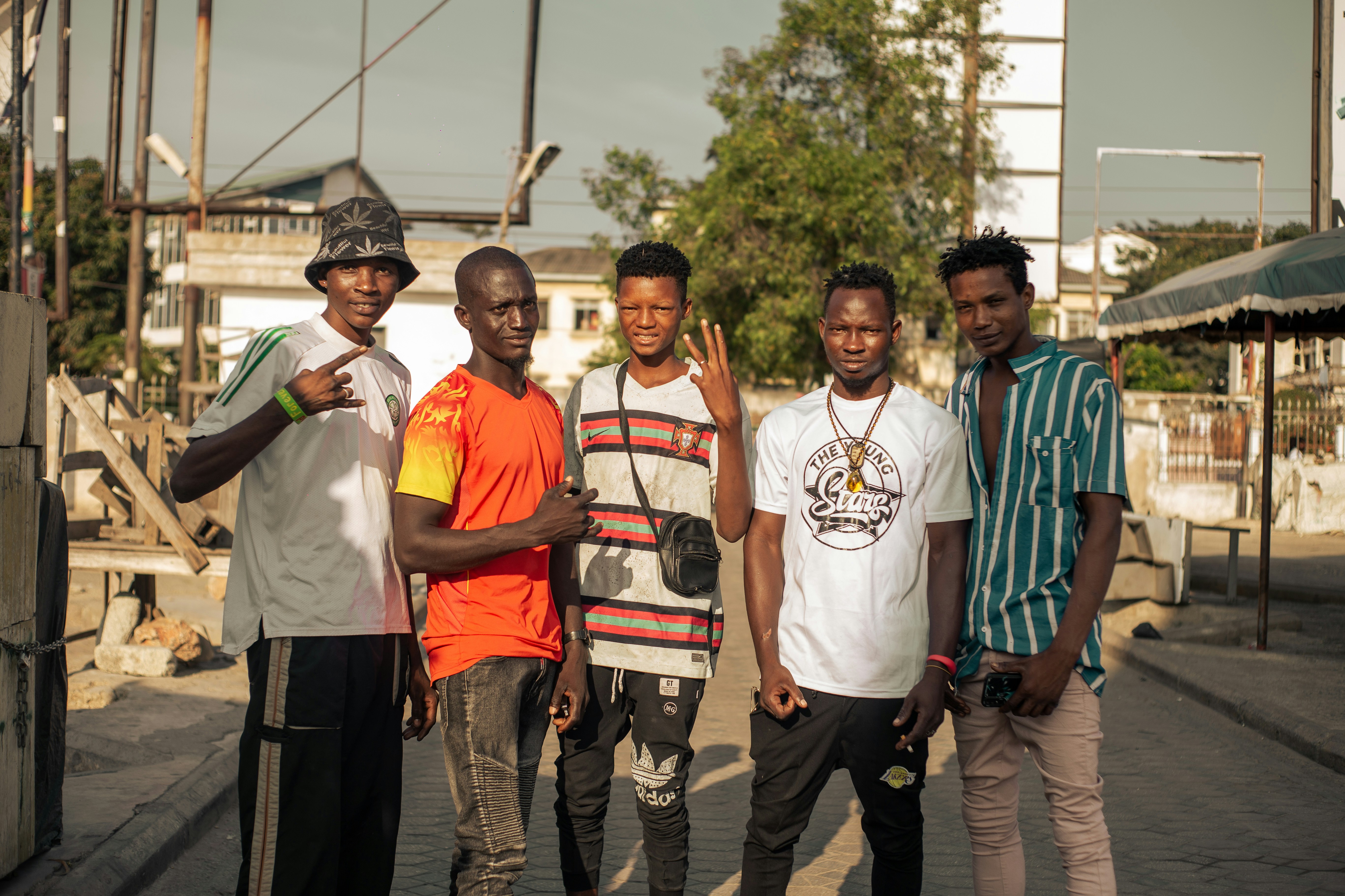 Crew of Street Portraits: Five Friends in a Sunlit Dockside Moment