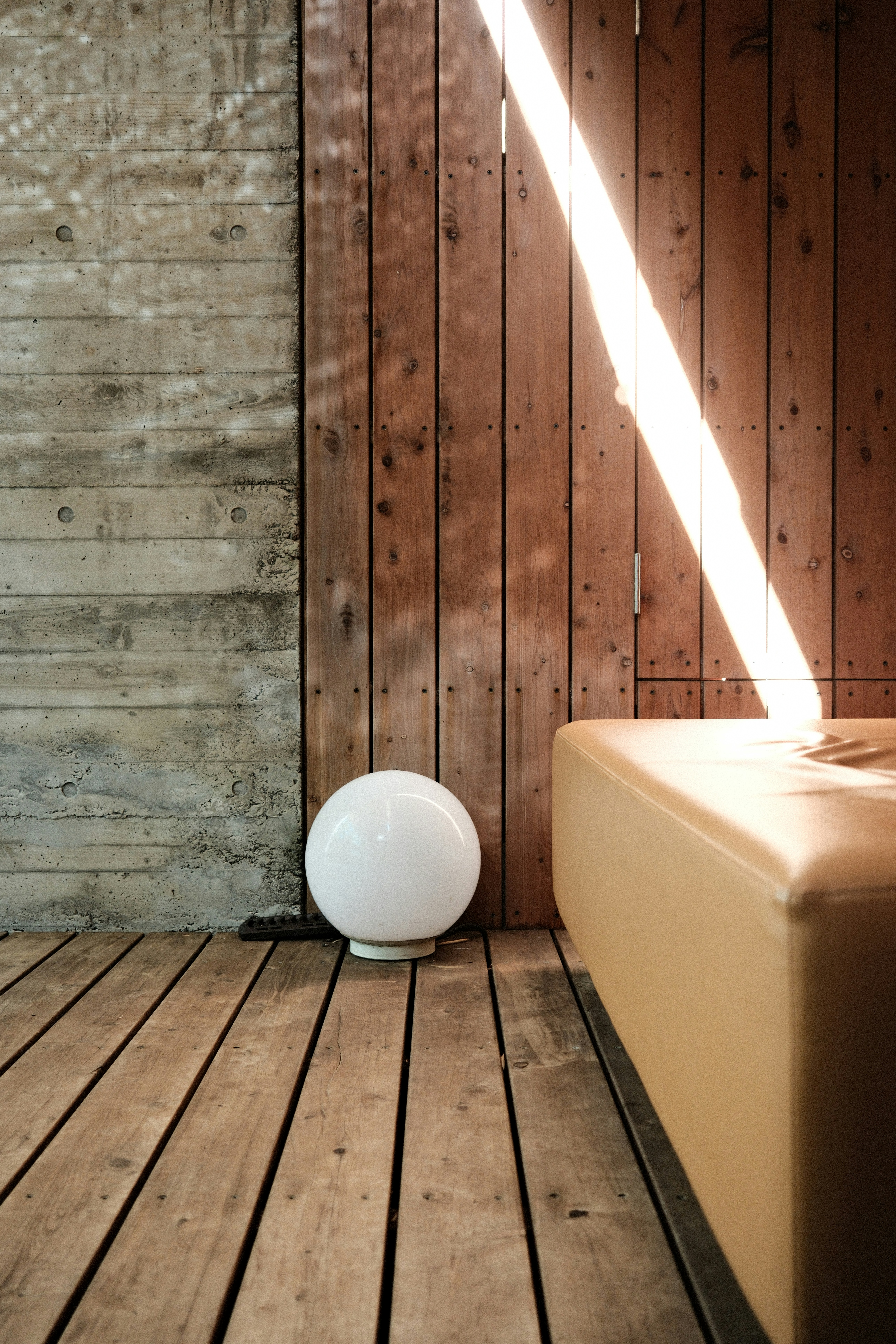 Mid-Cloor Contrast: A Sunlit Stripe Crossing the Wooden Wall