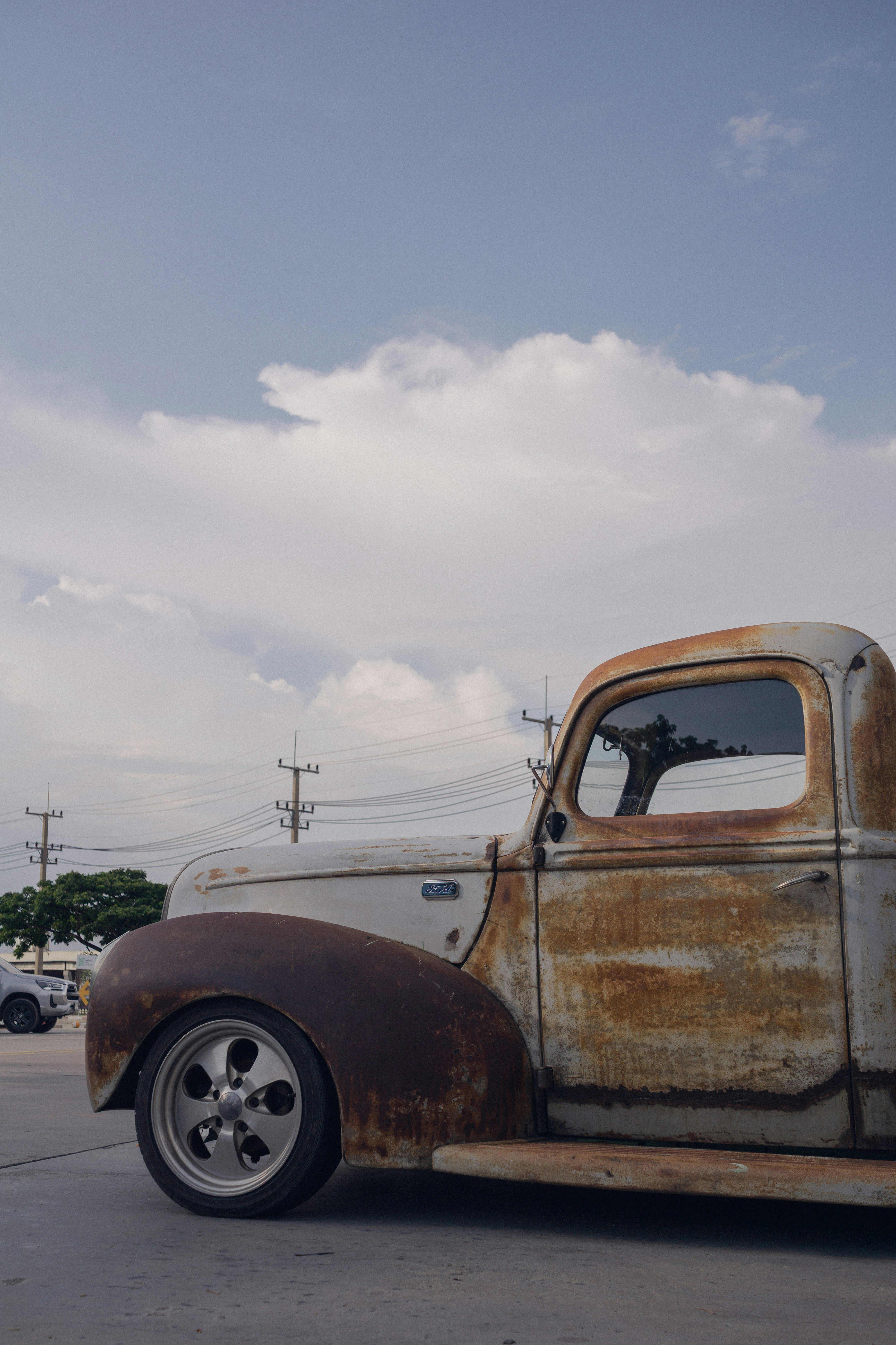 Rust Meets Road: A Weathered Classic Resting Under an Open Sky