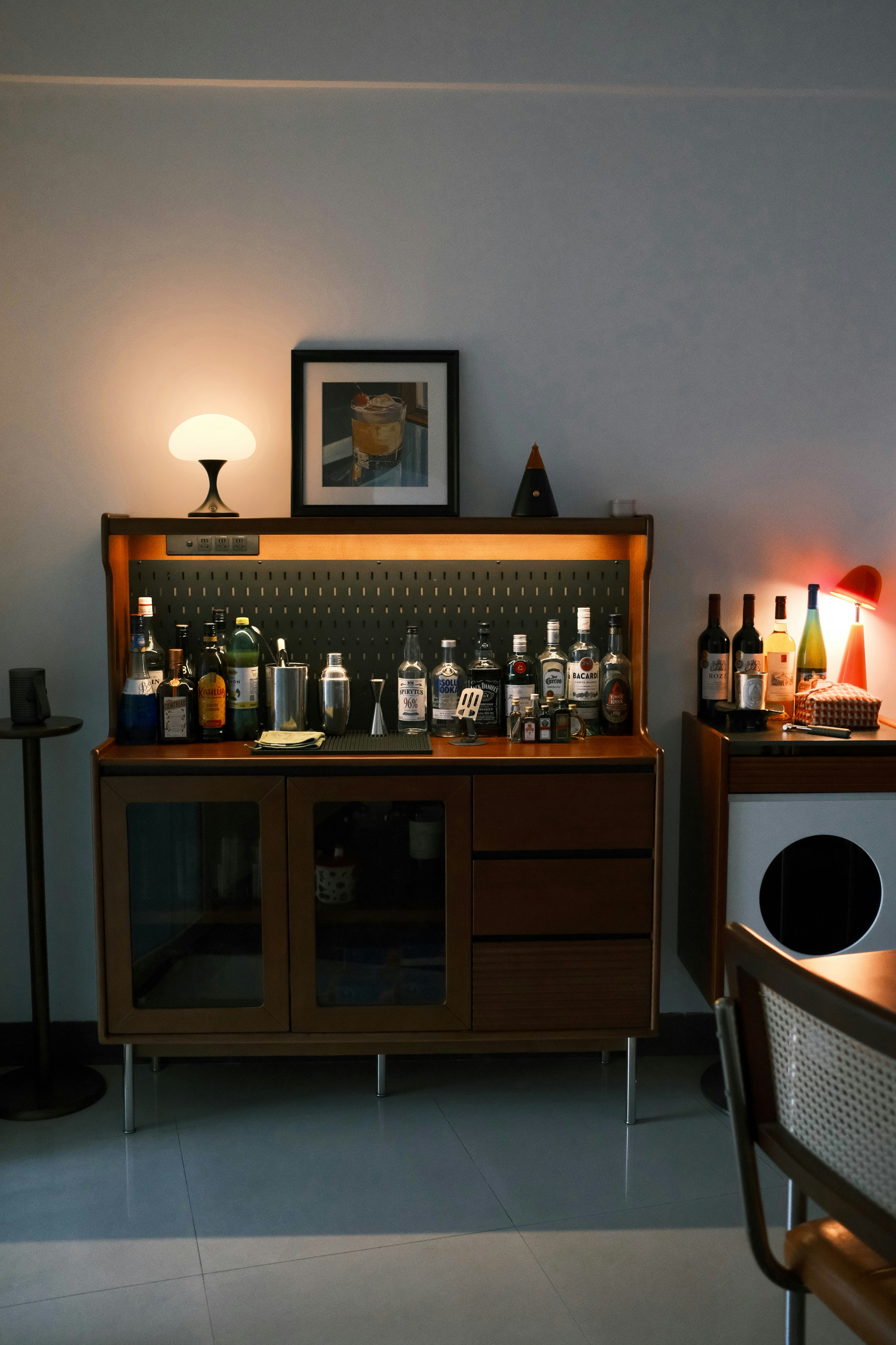 At-the-Bar Nook: a quiet still-life of bottles and lamp-lit wood