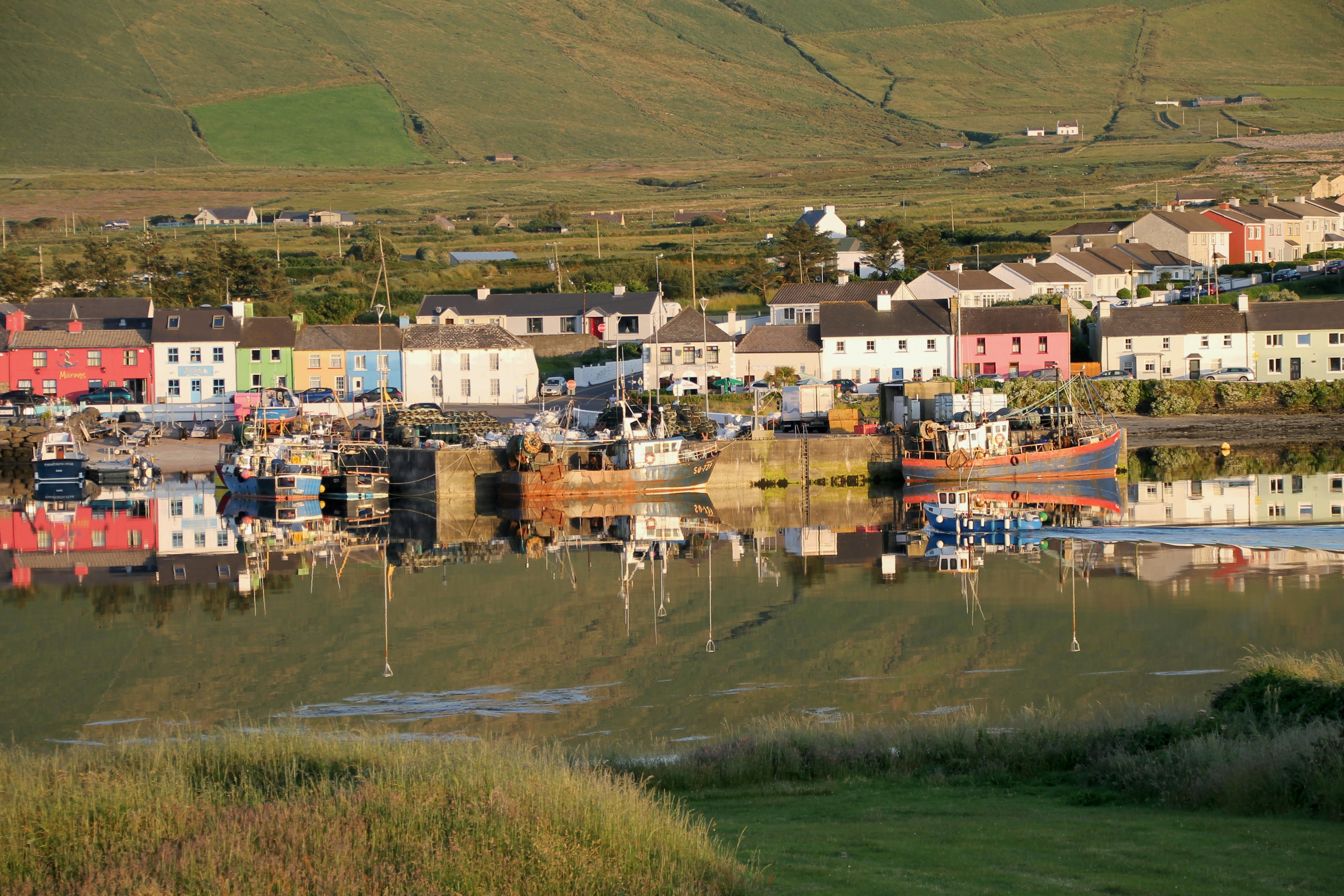 Harbor Village Reflections: Colorful Houses lining calm water at sunset