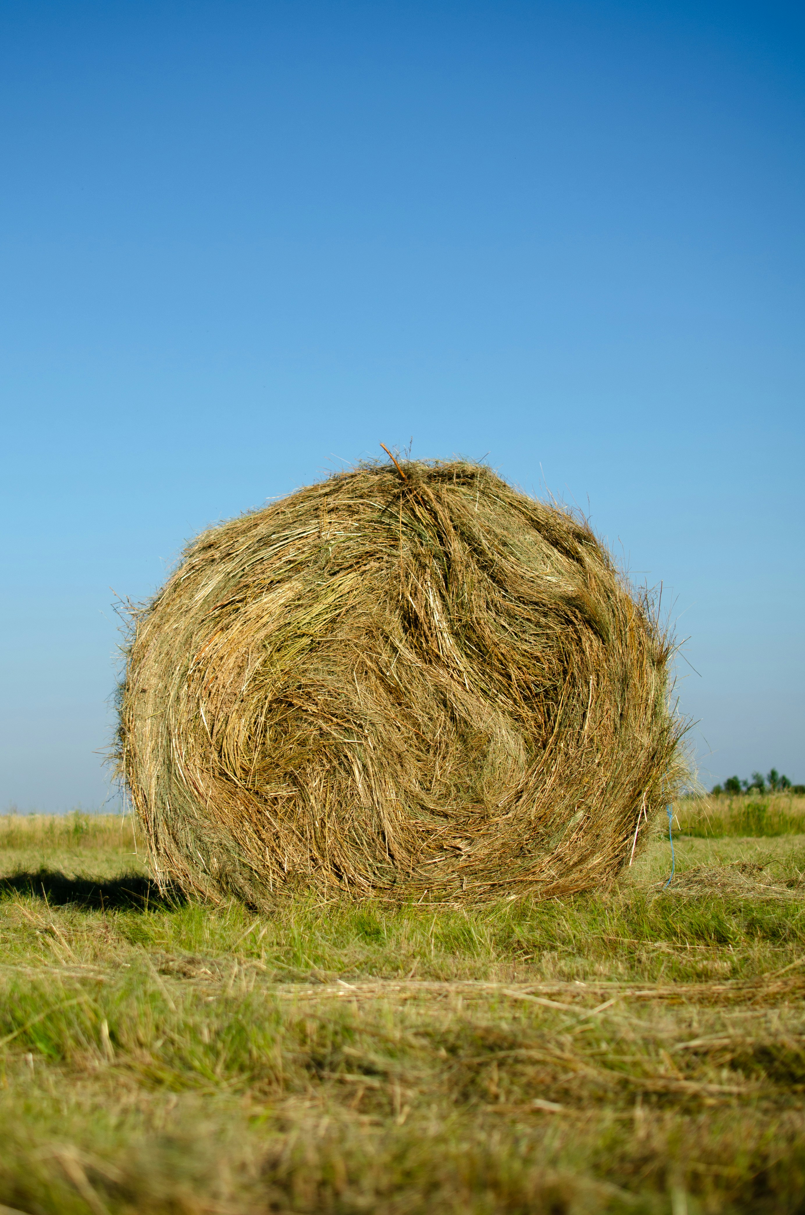 Spotlit Hay Bale Under Wide Sky
