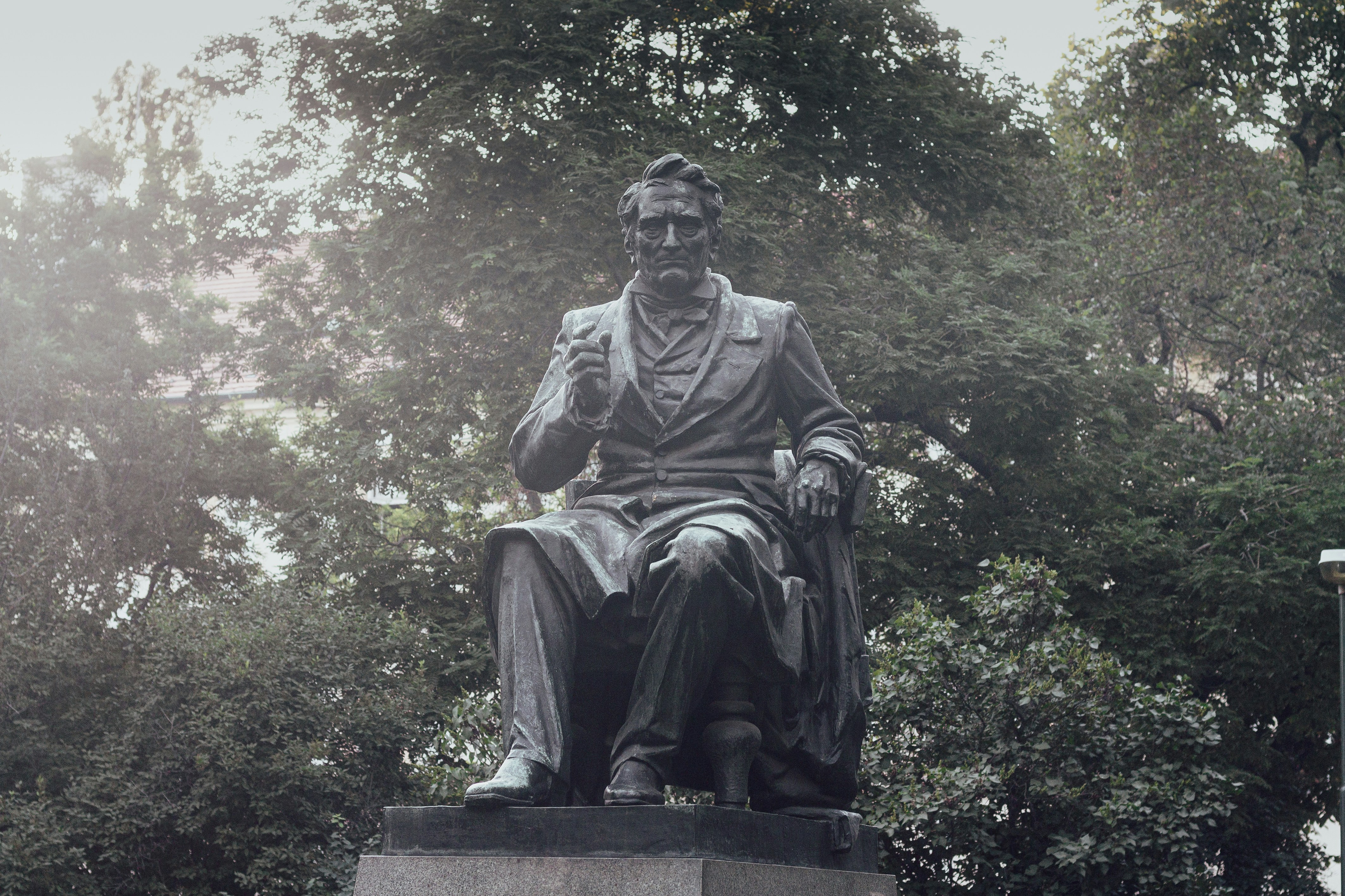Solemn Seated Figure: A Monumental Quiet Presence
