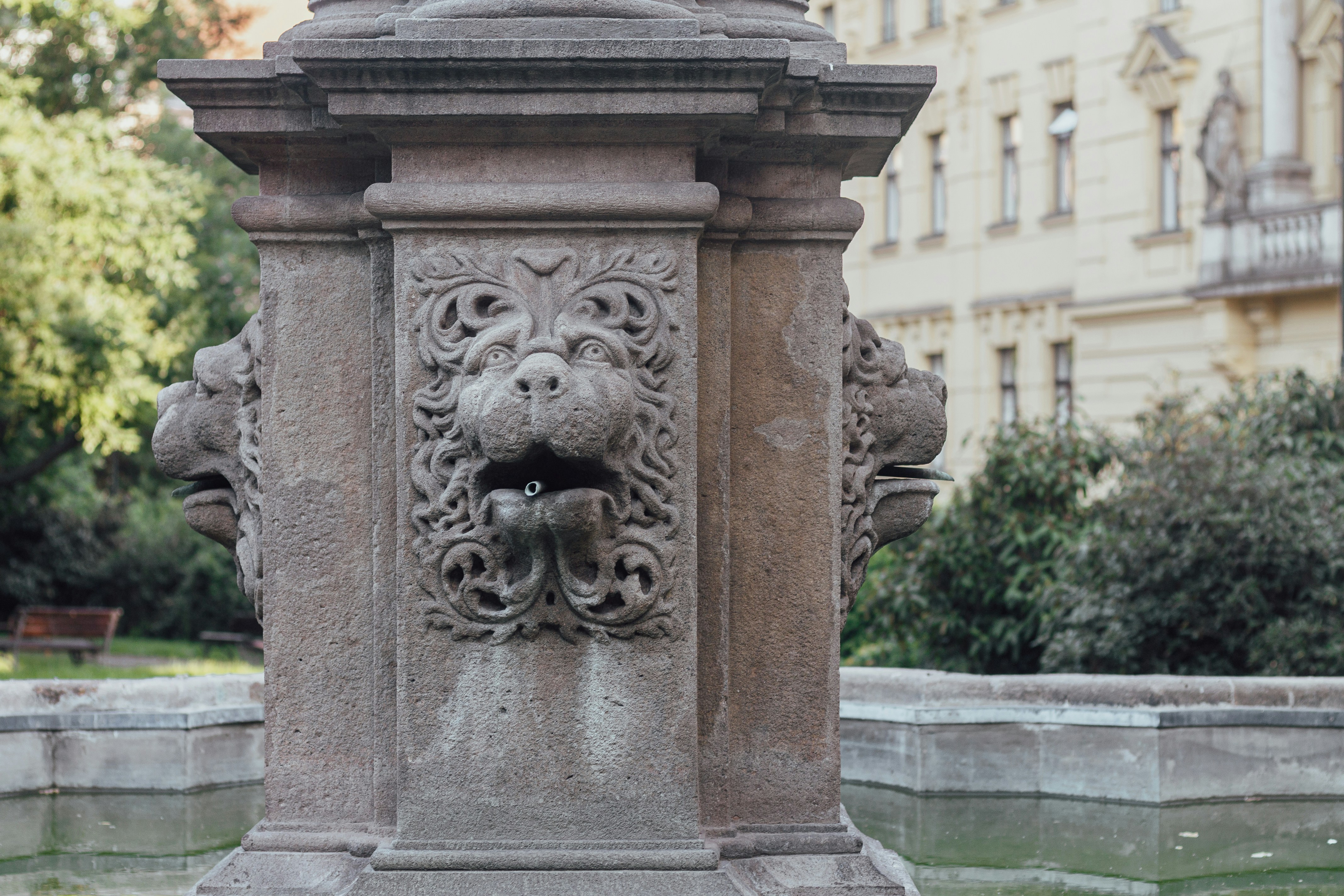 Stone Guardian: A Lion-Carved Fountain Stands Sentry Over a Courtyard