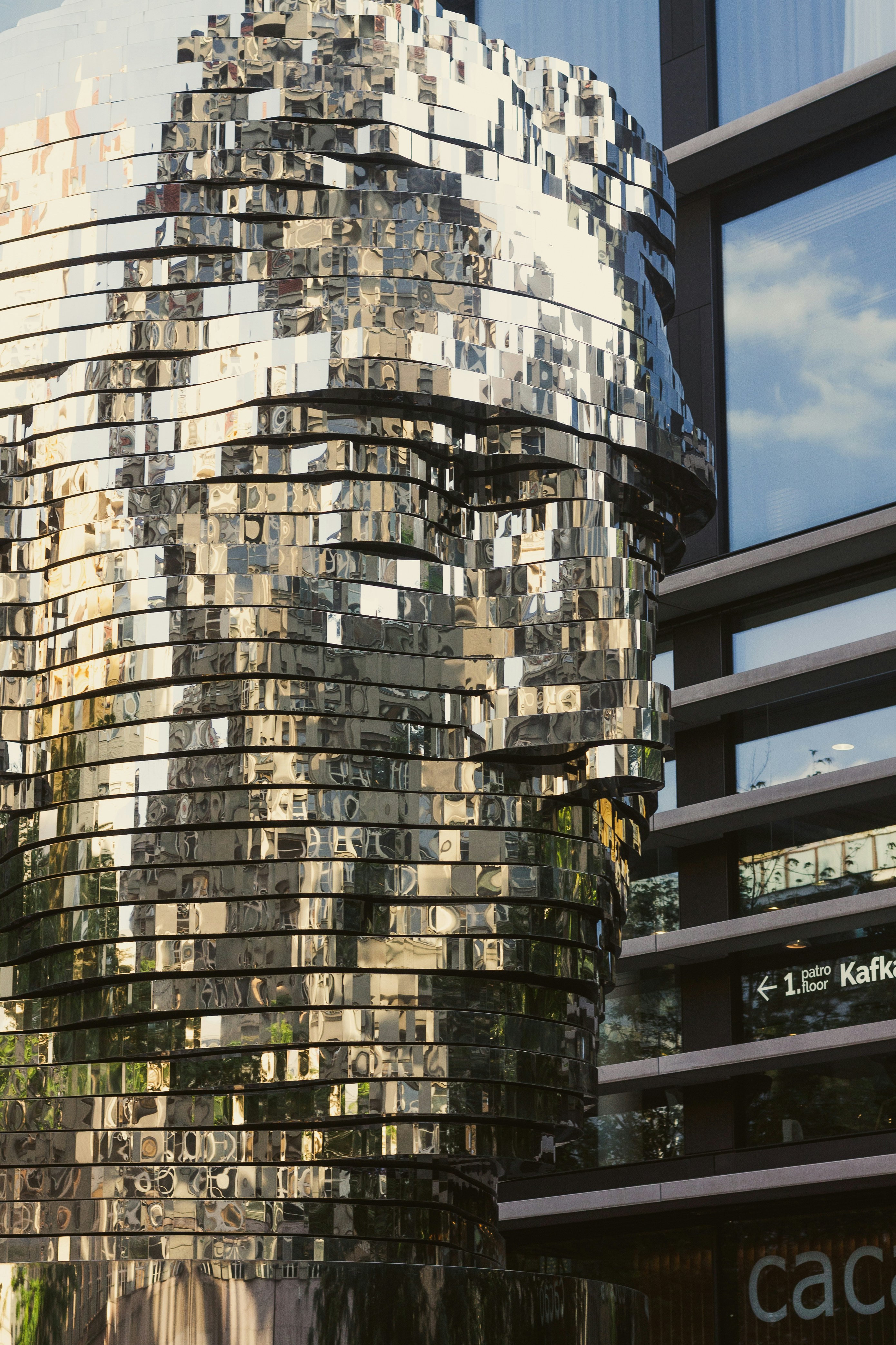 Gilded Facade: A Reflective Spiral Crown on a Contemporary Building