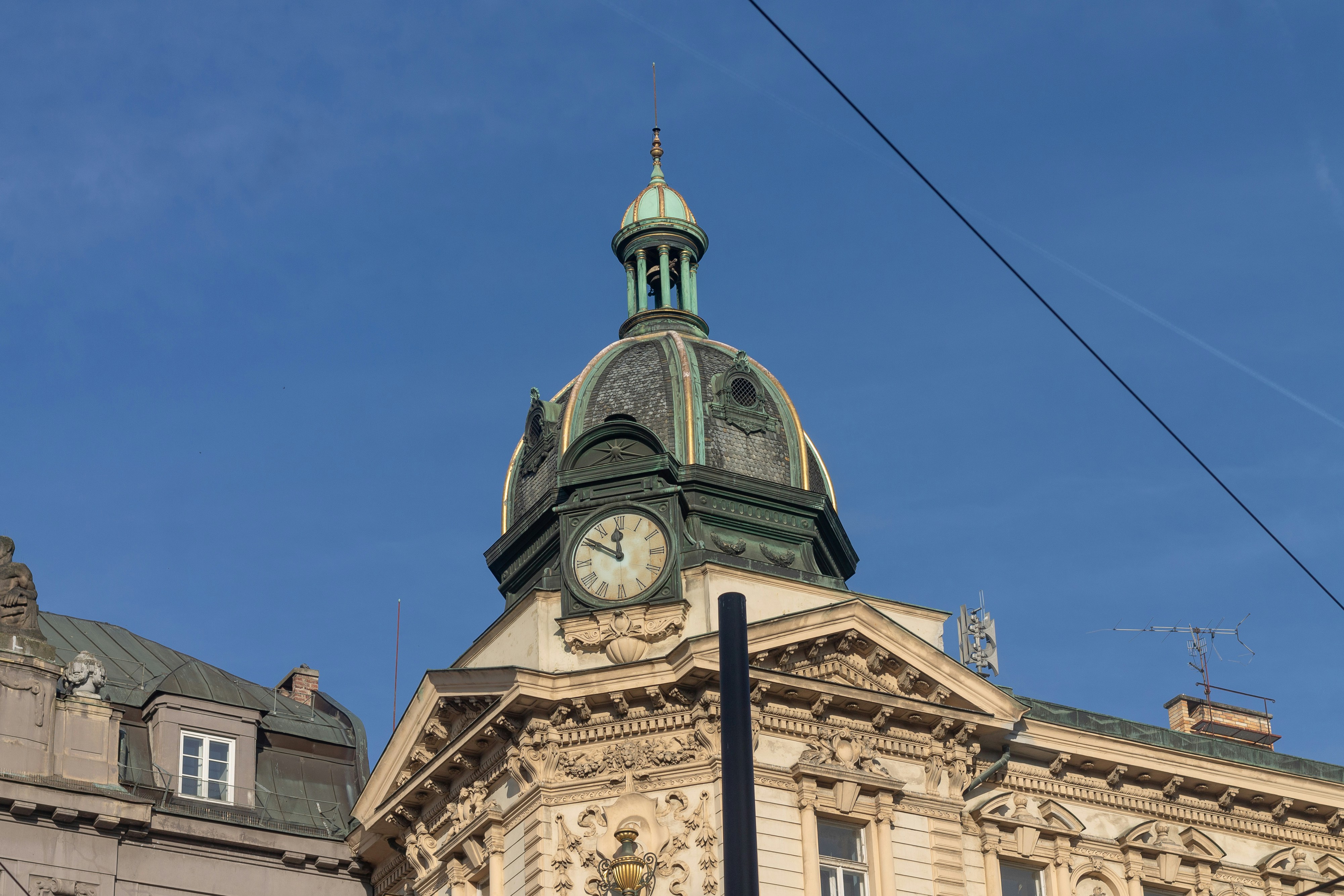 Clocktower Crown: A Historic Facade Rising Under a Clear Blue