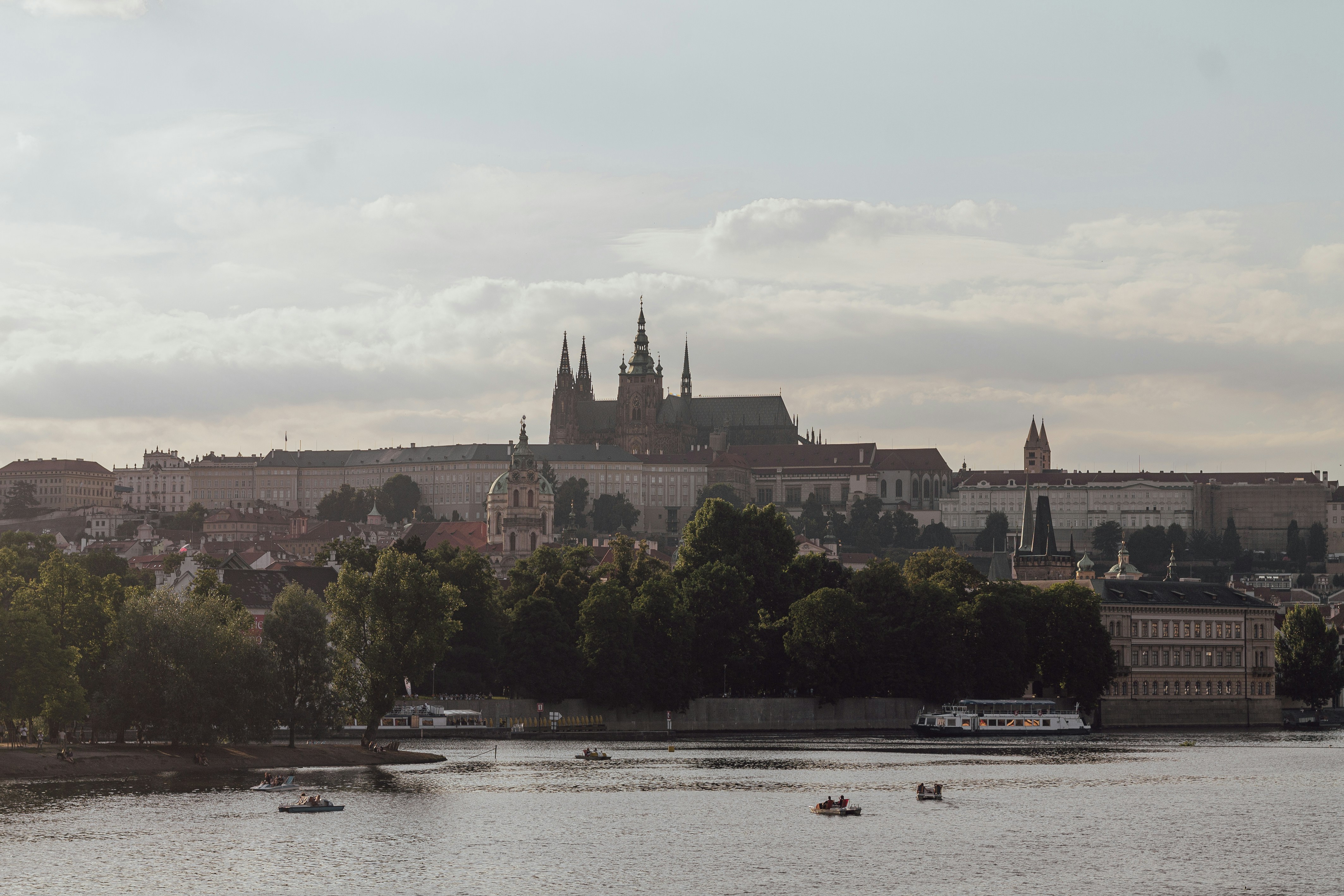 Riverside silhouette: a distant castle on the hill above the amber river