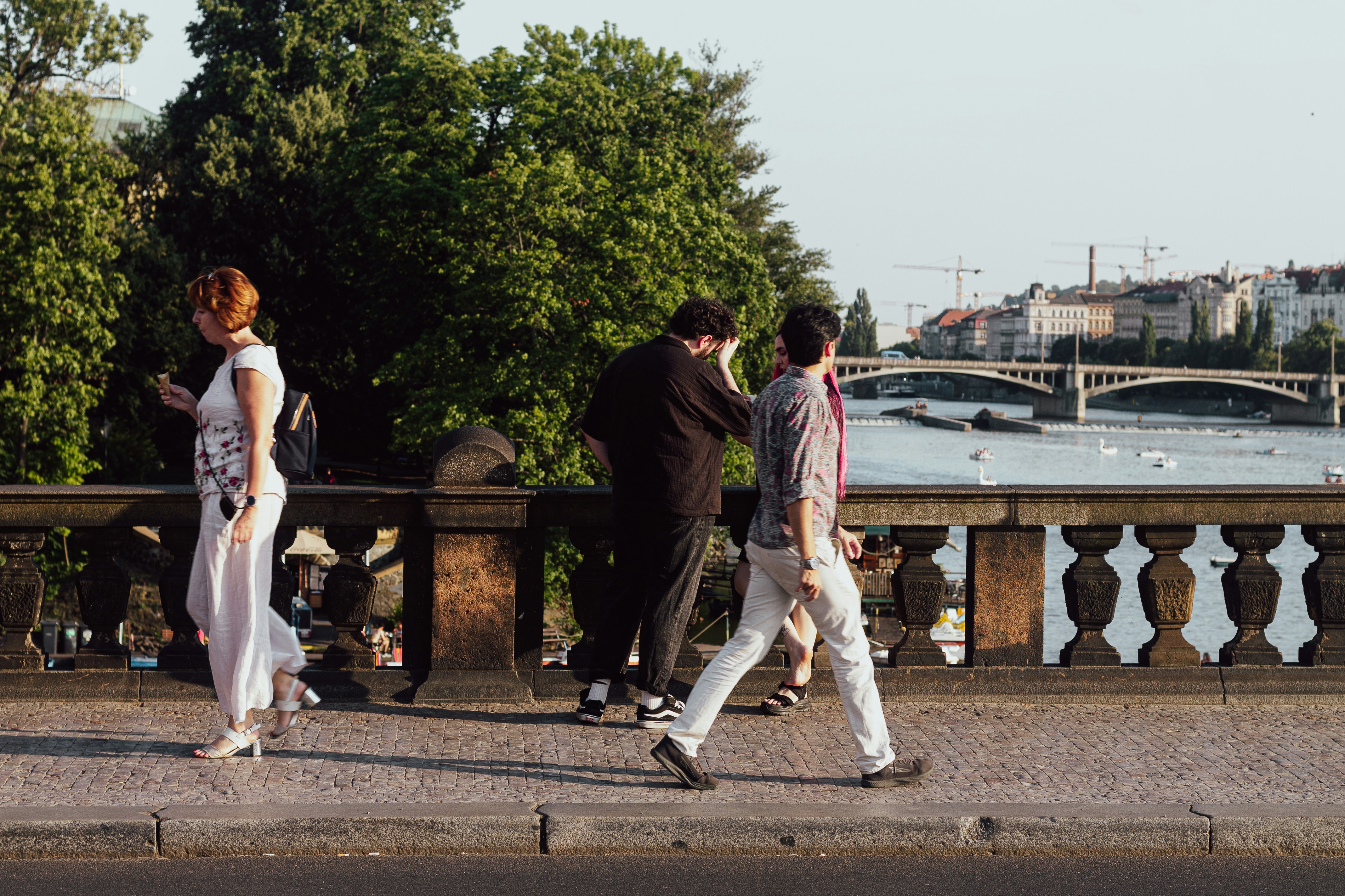 Riverwalk in Motion: a casual mid-afternoon scene by the water