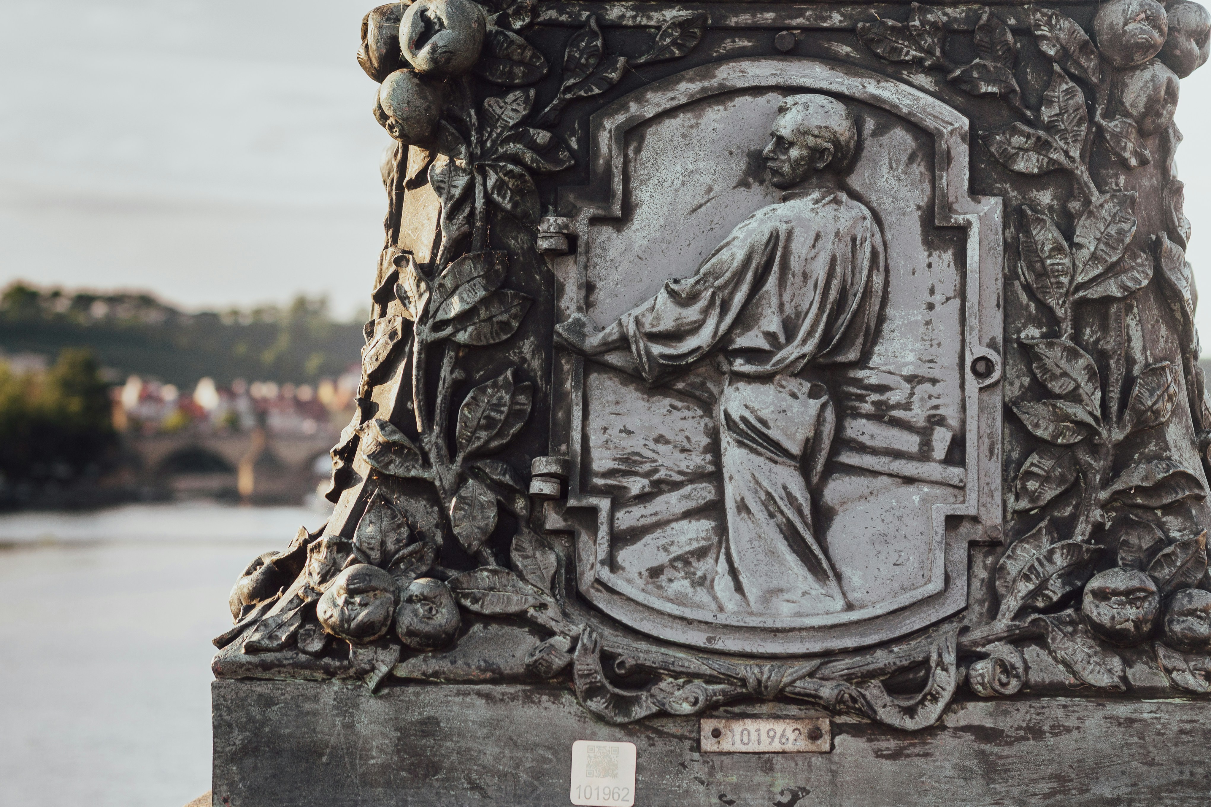 Emblem in Stone: A Weathered Carving Framed by River Light