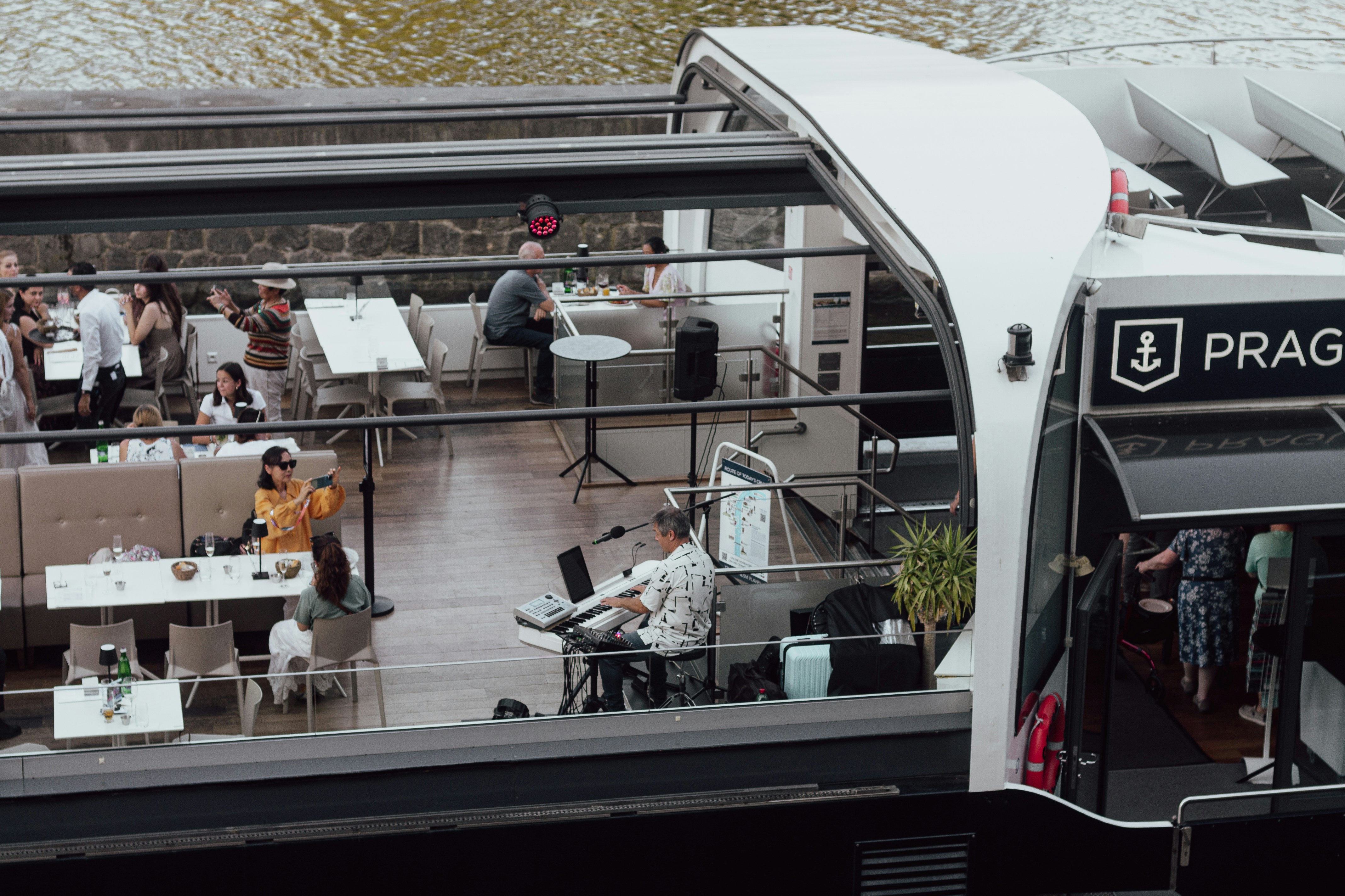 Aerial Stage: Musicians and Passengers on a Riverboat Terrace