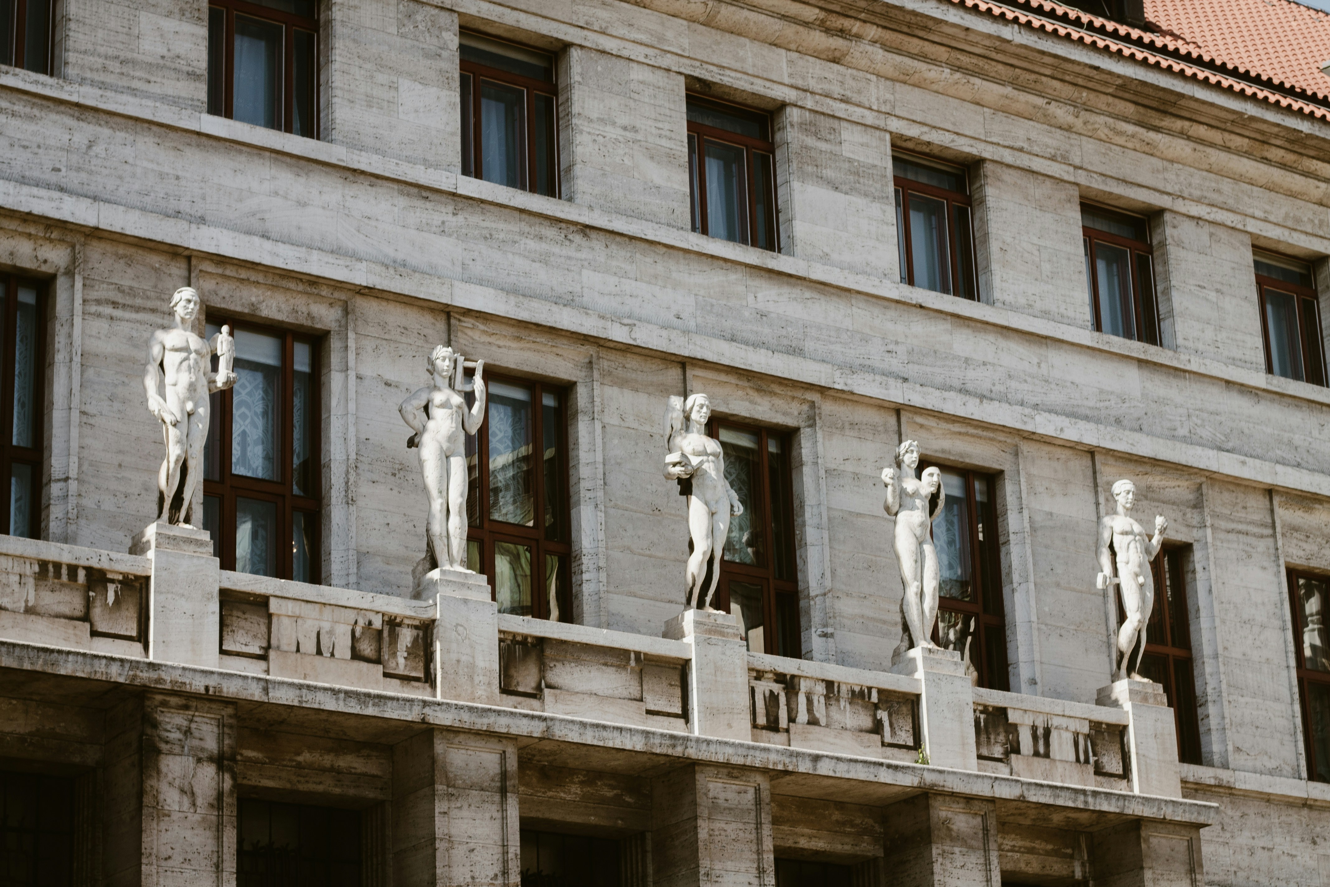 Statues on a Weathered Veranda: Dawn Light on Classical Figures