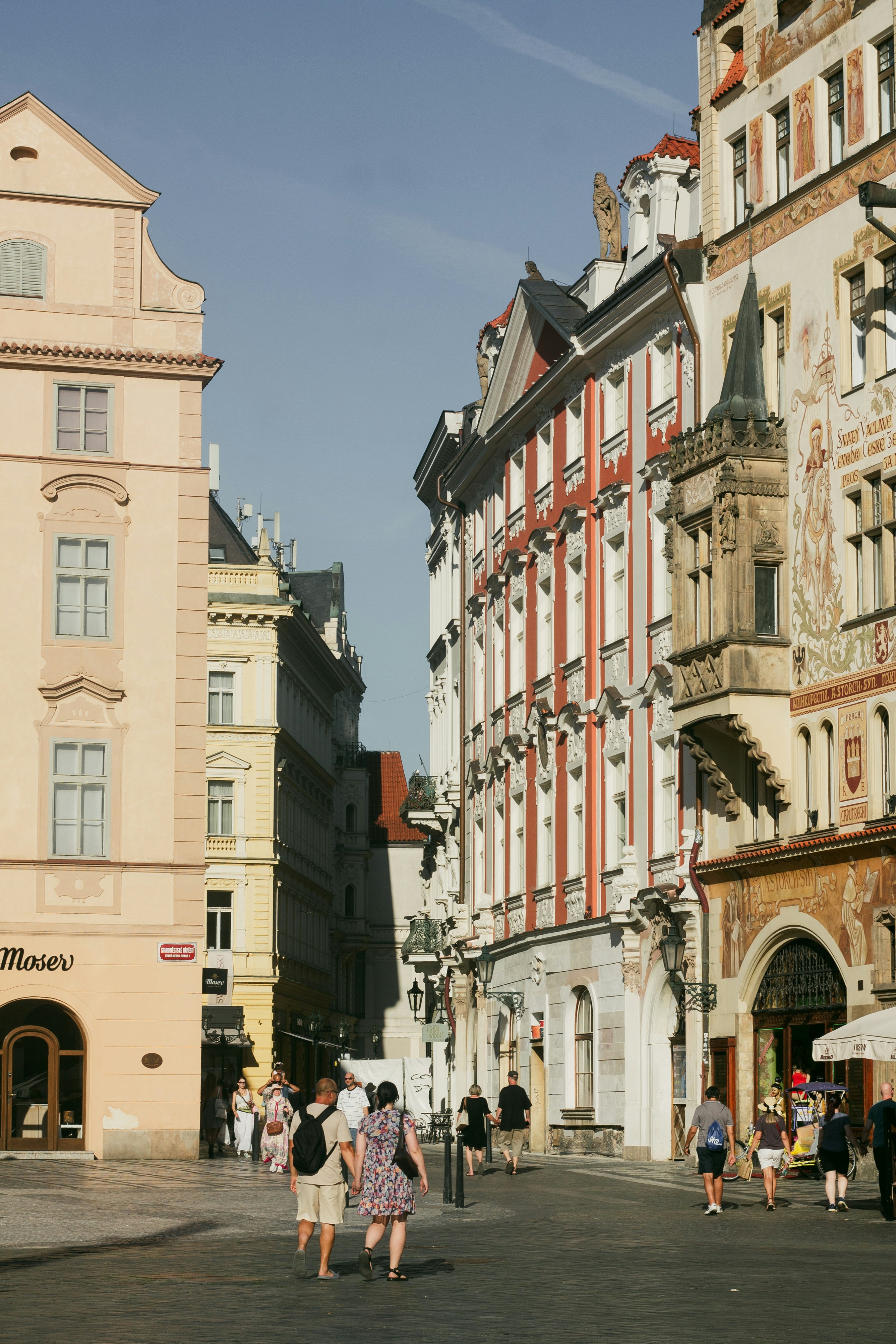 Sunlit Street of Echoes: Historic Facades and Quiet Pedestrians in Warm Light