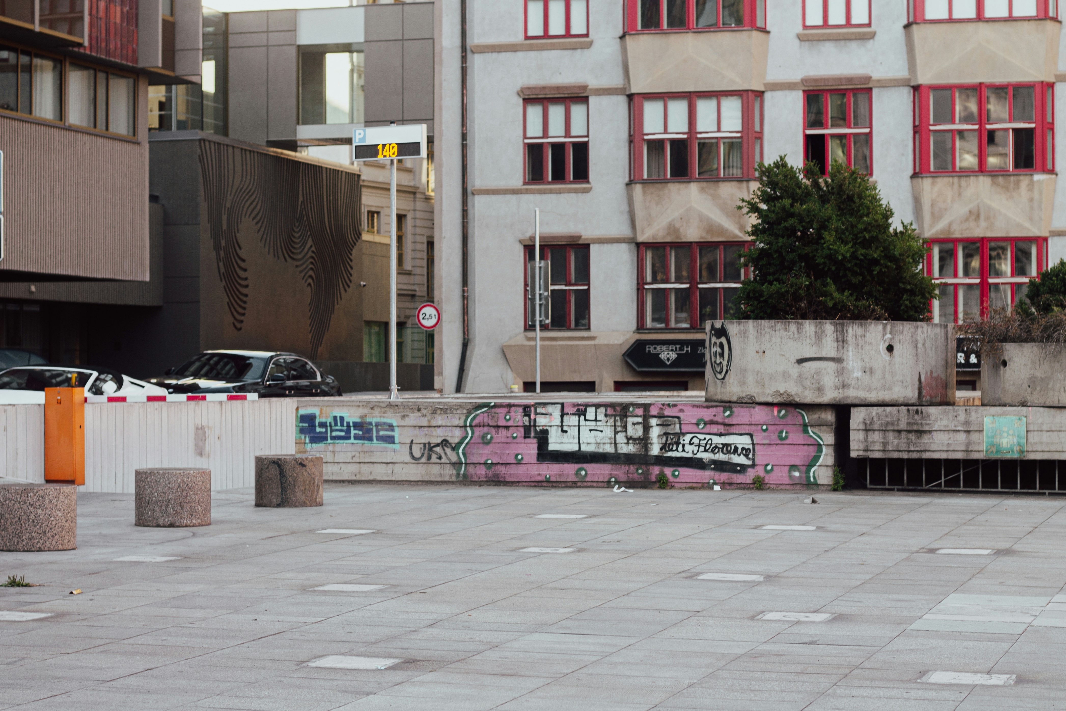 Graffiti Wall and Urban Courtyard Framed by Neutral Architecture
