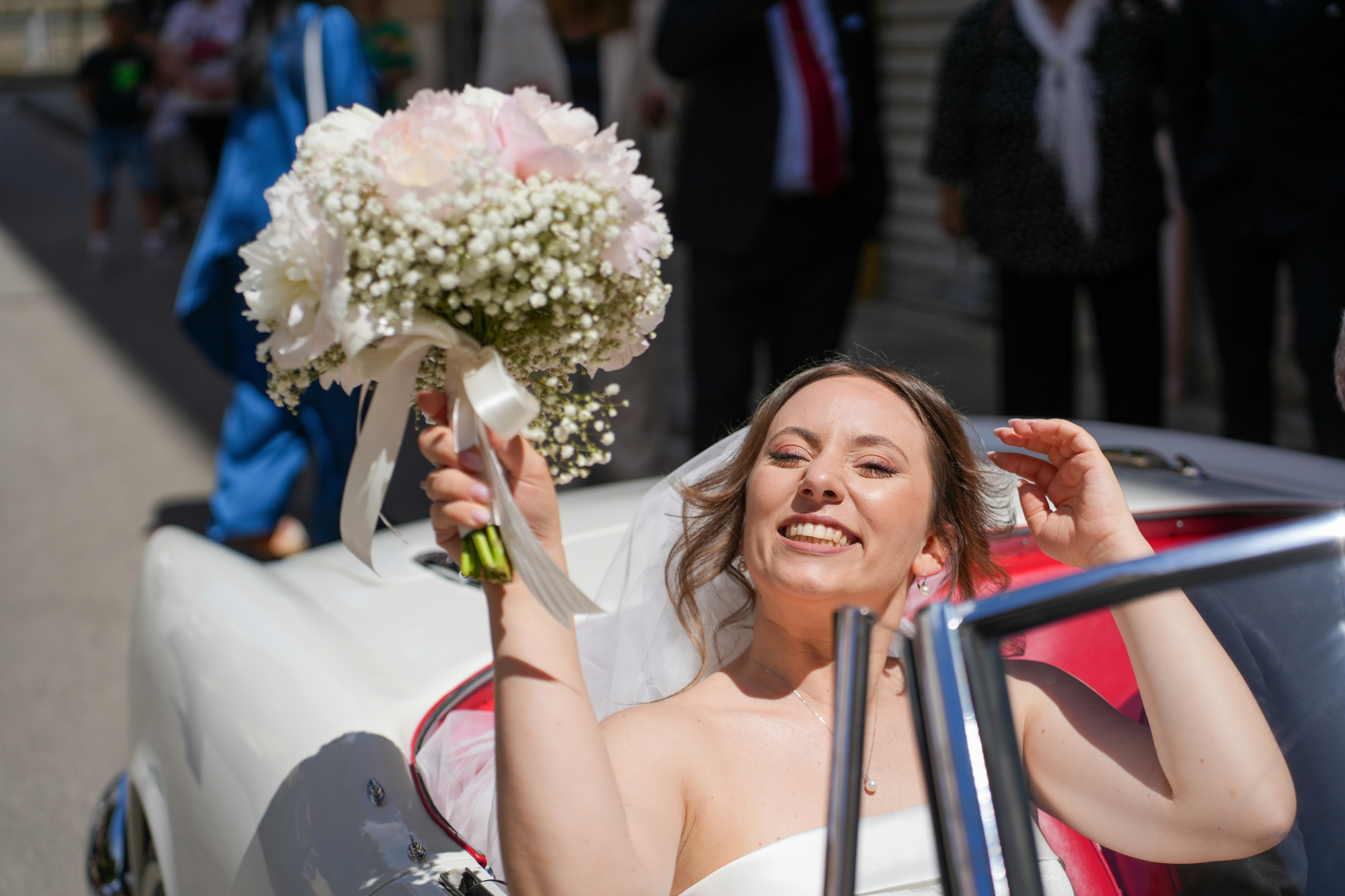 Bridal Joy in a Convertible: Bouquet Lift and Smile