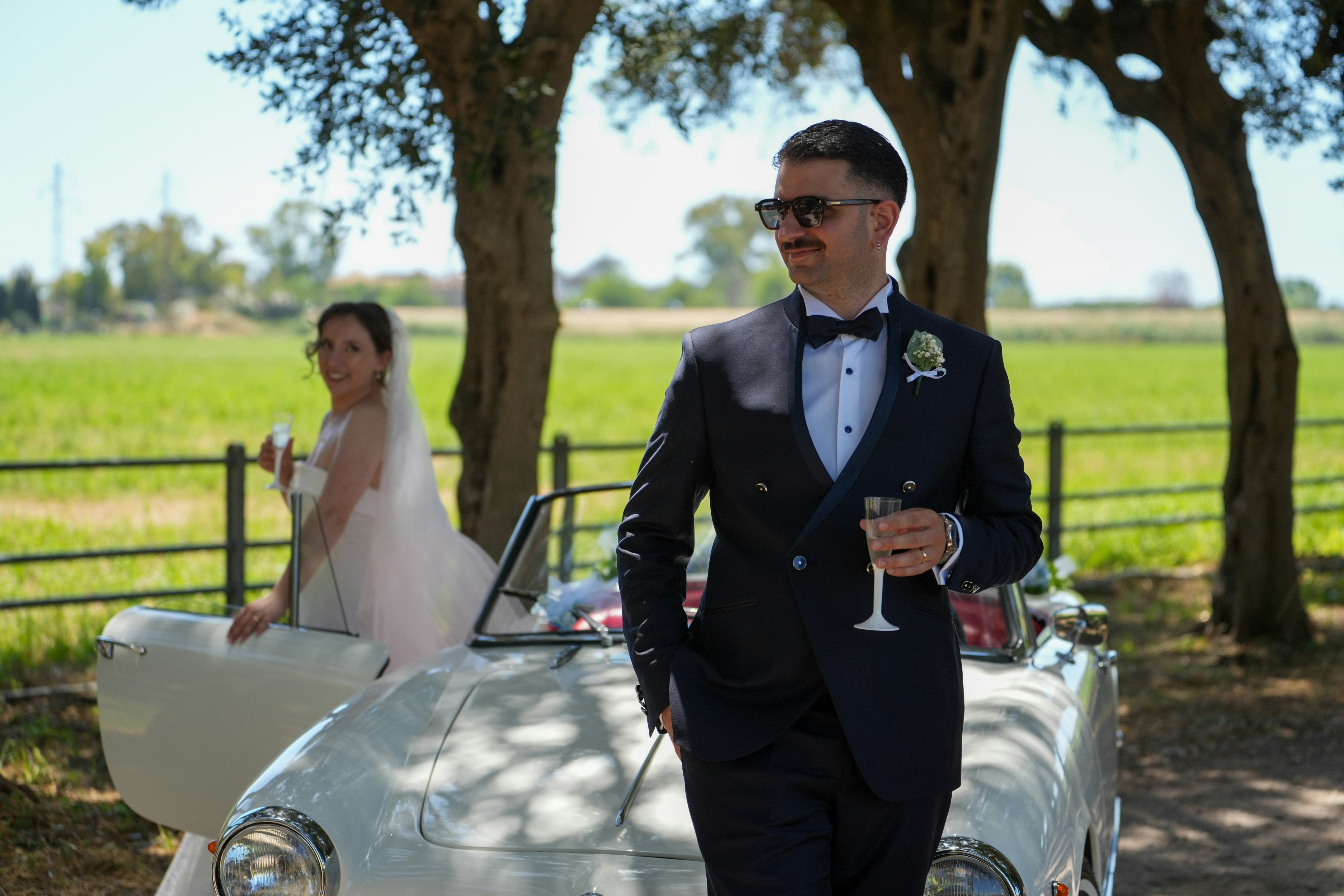 Groom in Noir-Tie Vigil by a Vintage Convertible
