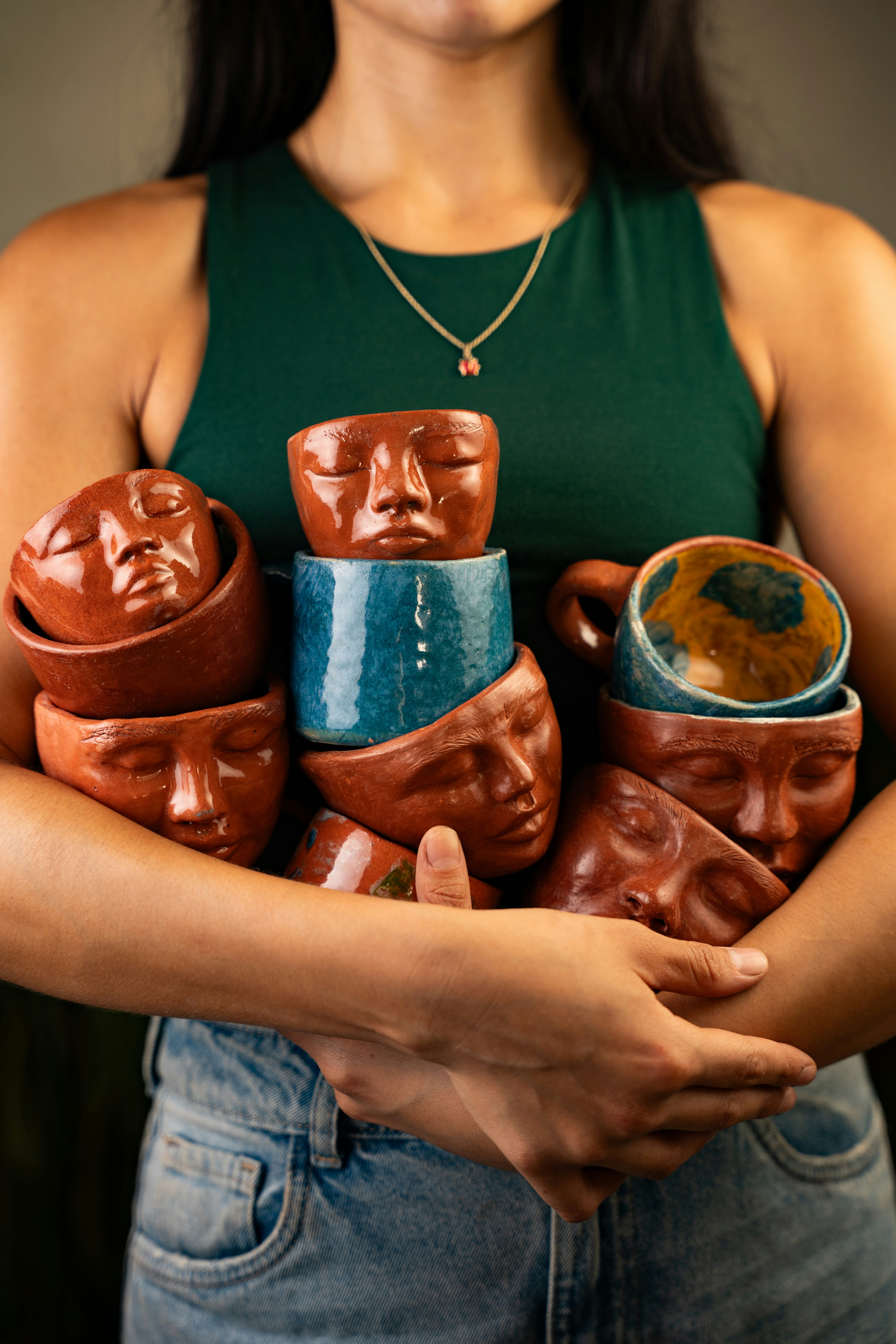 Terracotta Faces Embrace: A Handful of Mementos in Color