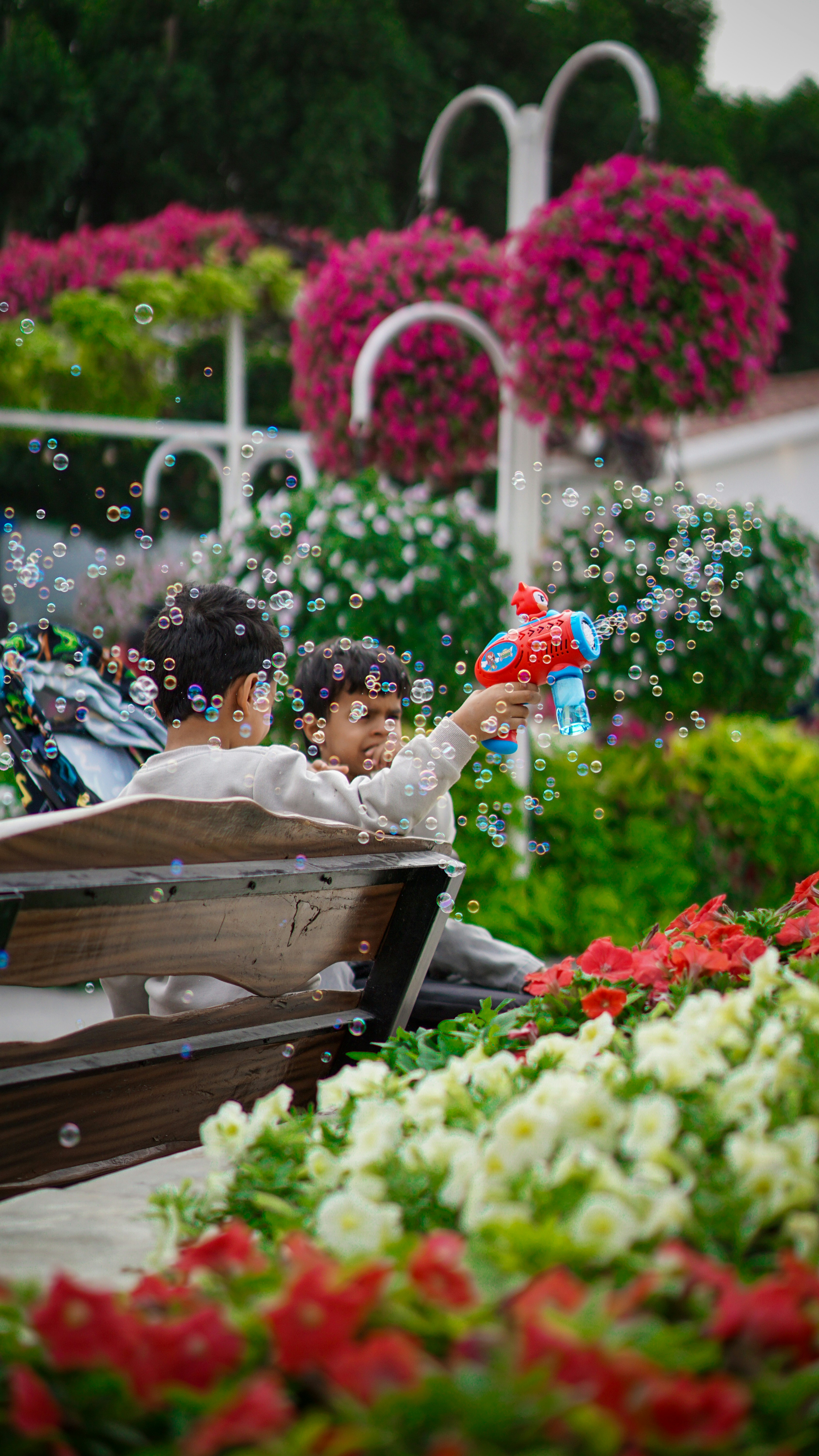 Bubble-filled Blast: A Toy Gun Cheerfully Shoots Water Across a Garden Parade