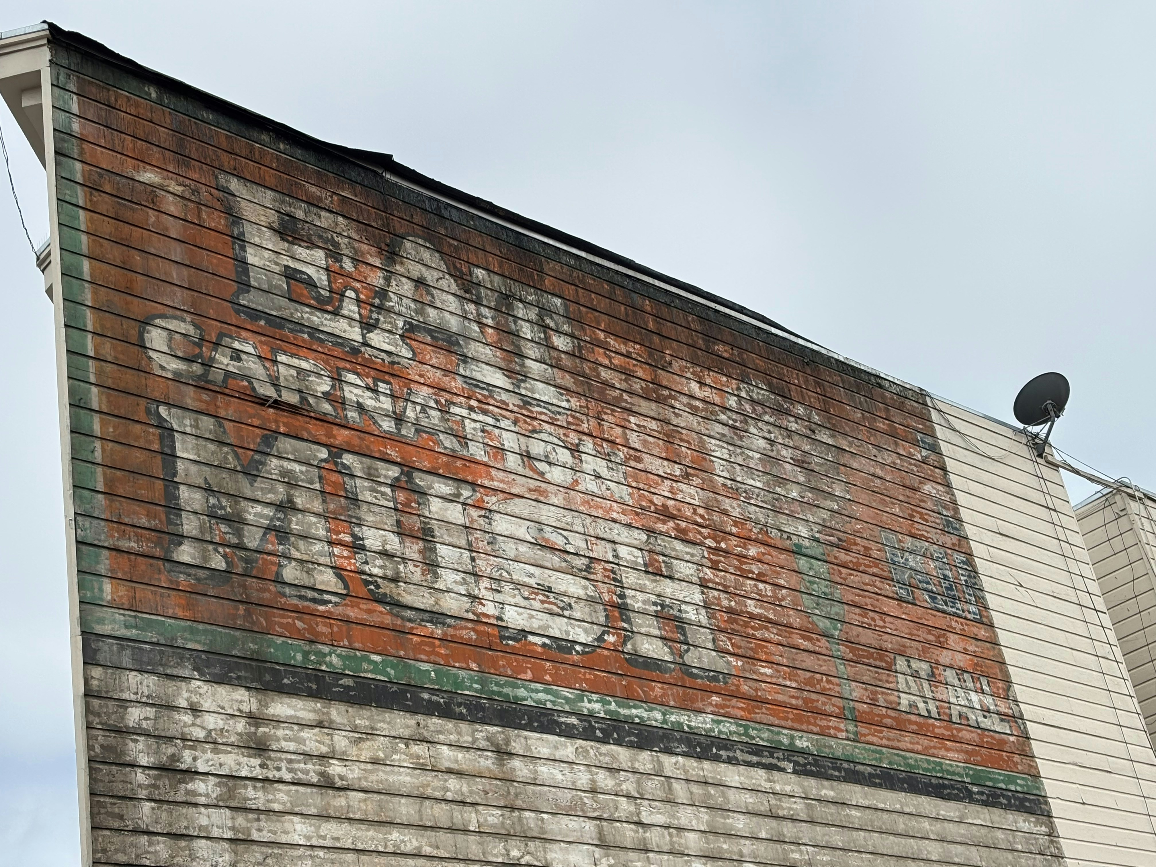 Weathered Signboard on a Brick Facade