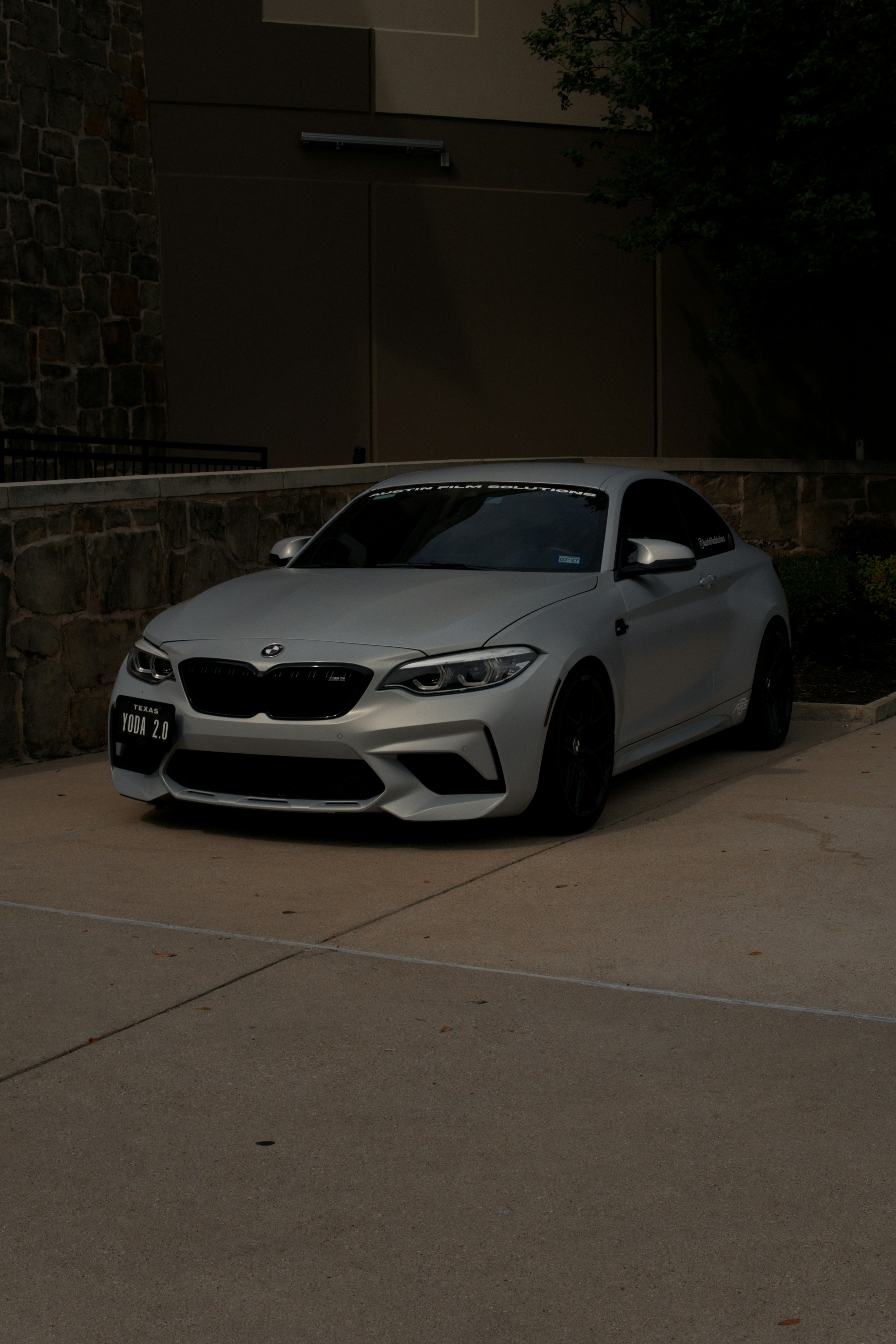 Low-Light Chrome: A White BMW Staged in a Dusk-Soft Parking Lot