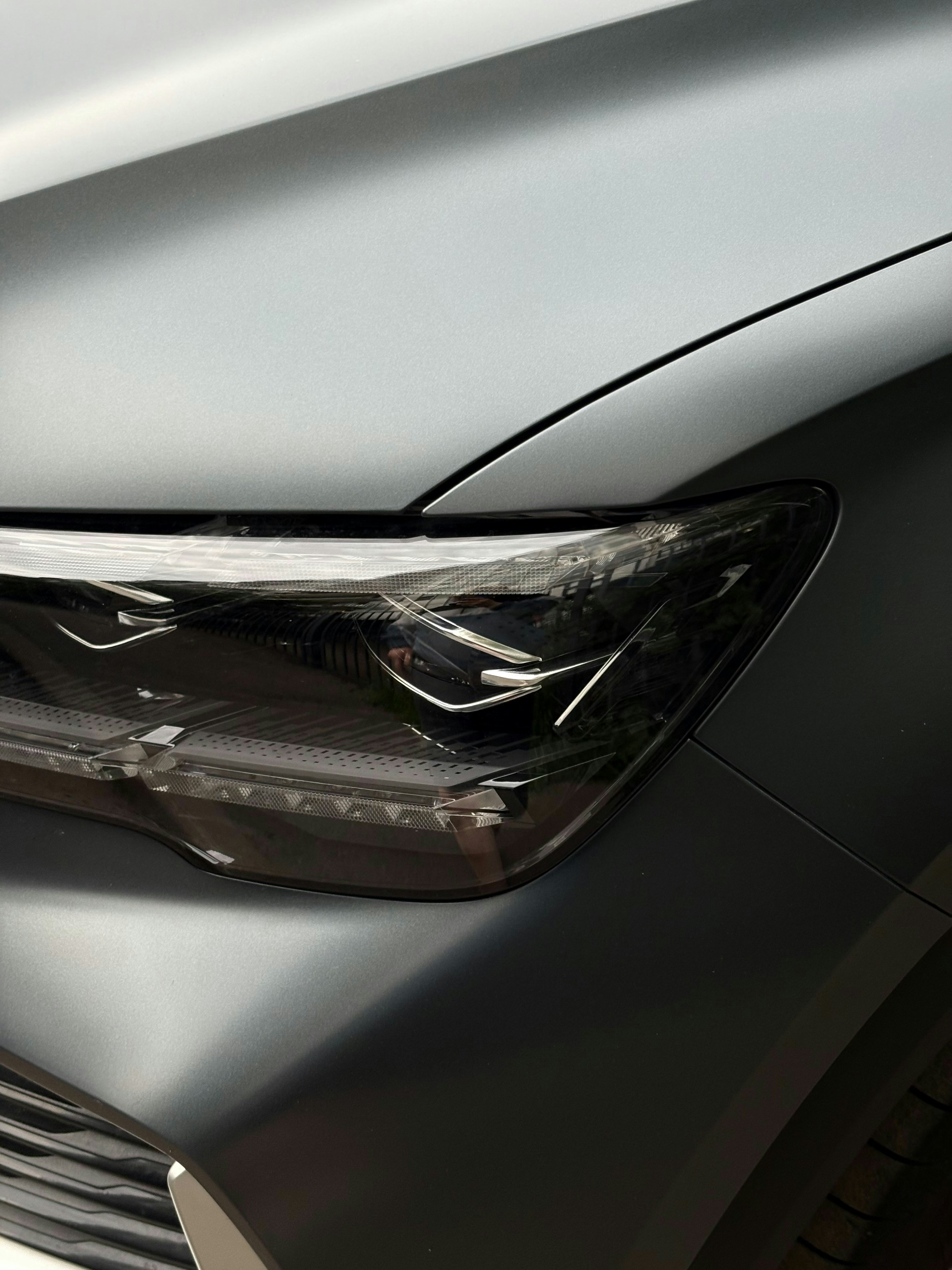 Close-up of a Matte Gray Car Headlight with Sharp Contours