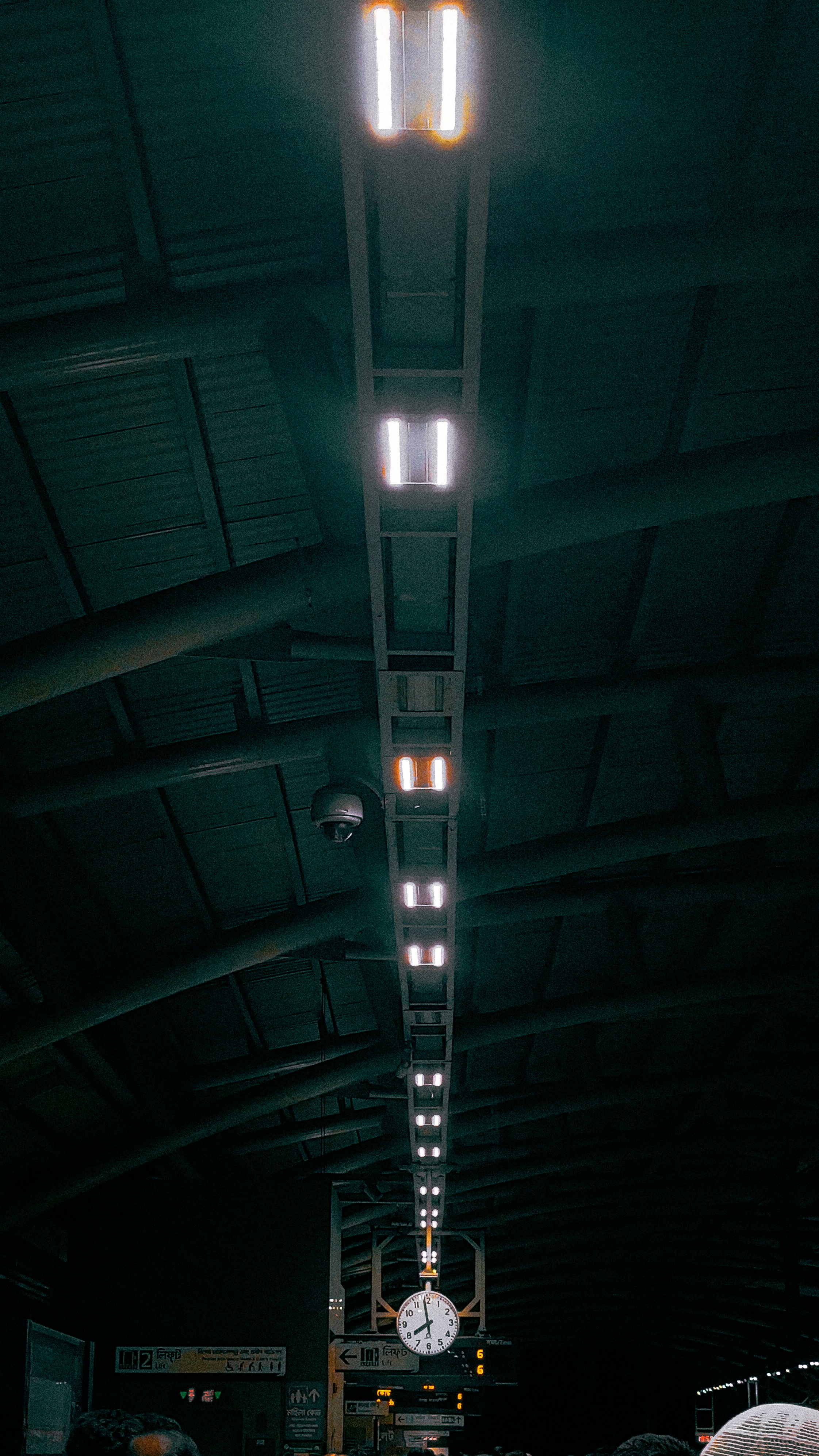 Midnight Train Station: A Neon Corridor Under Steel Beams
