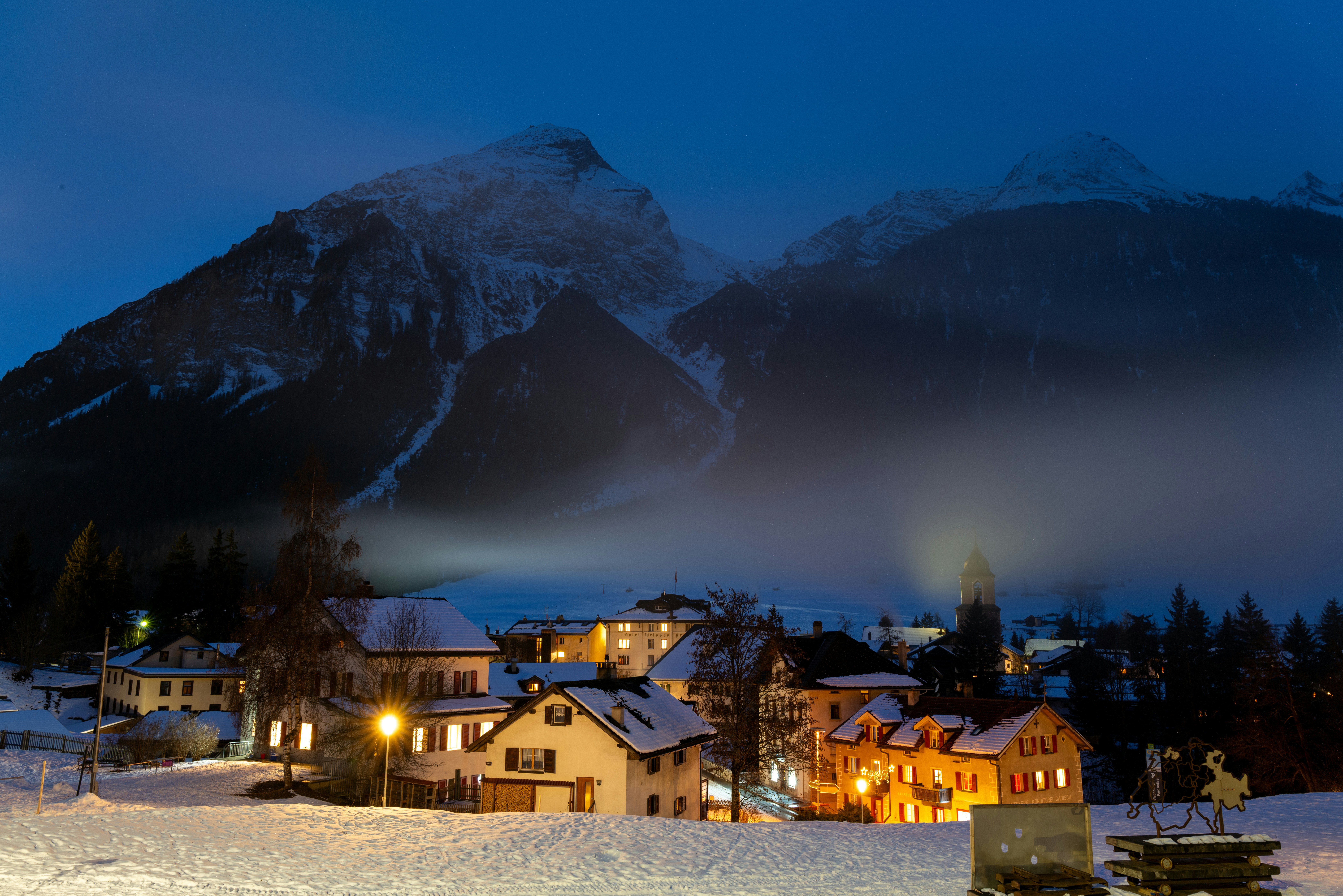 Lamp-lit chalets beneath frost-covered peaks