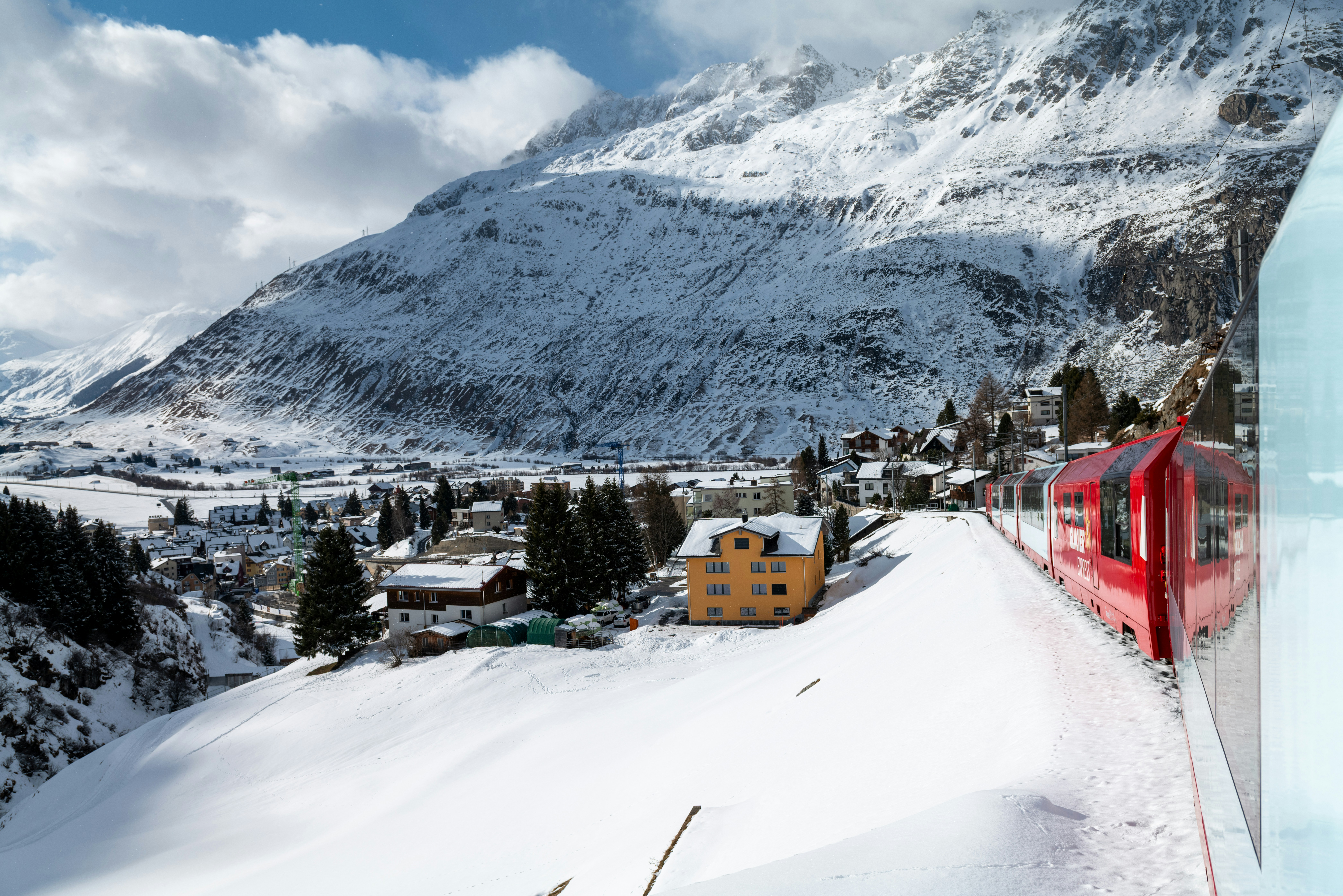 Snowbound Ridge: A Red Train Cuts Through a Quiet Alpine Village