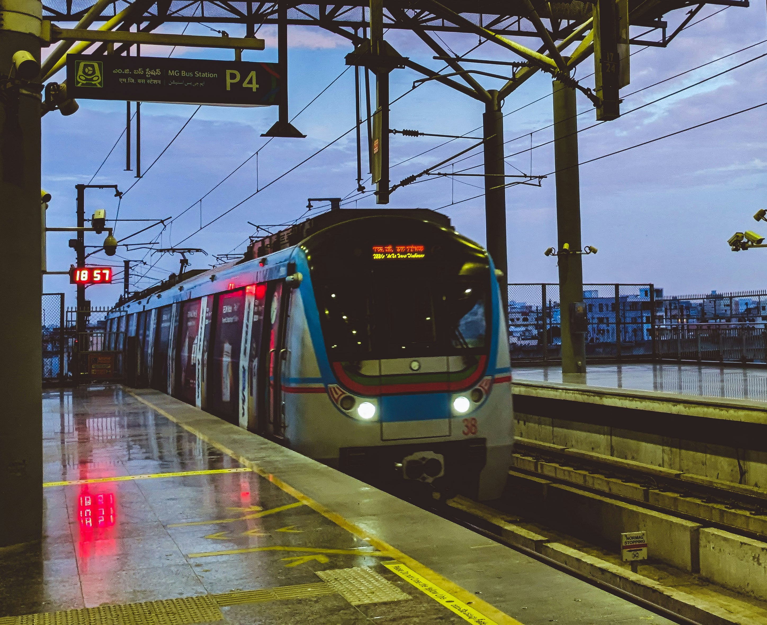 A modern metro train arriving at a station platform.