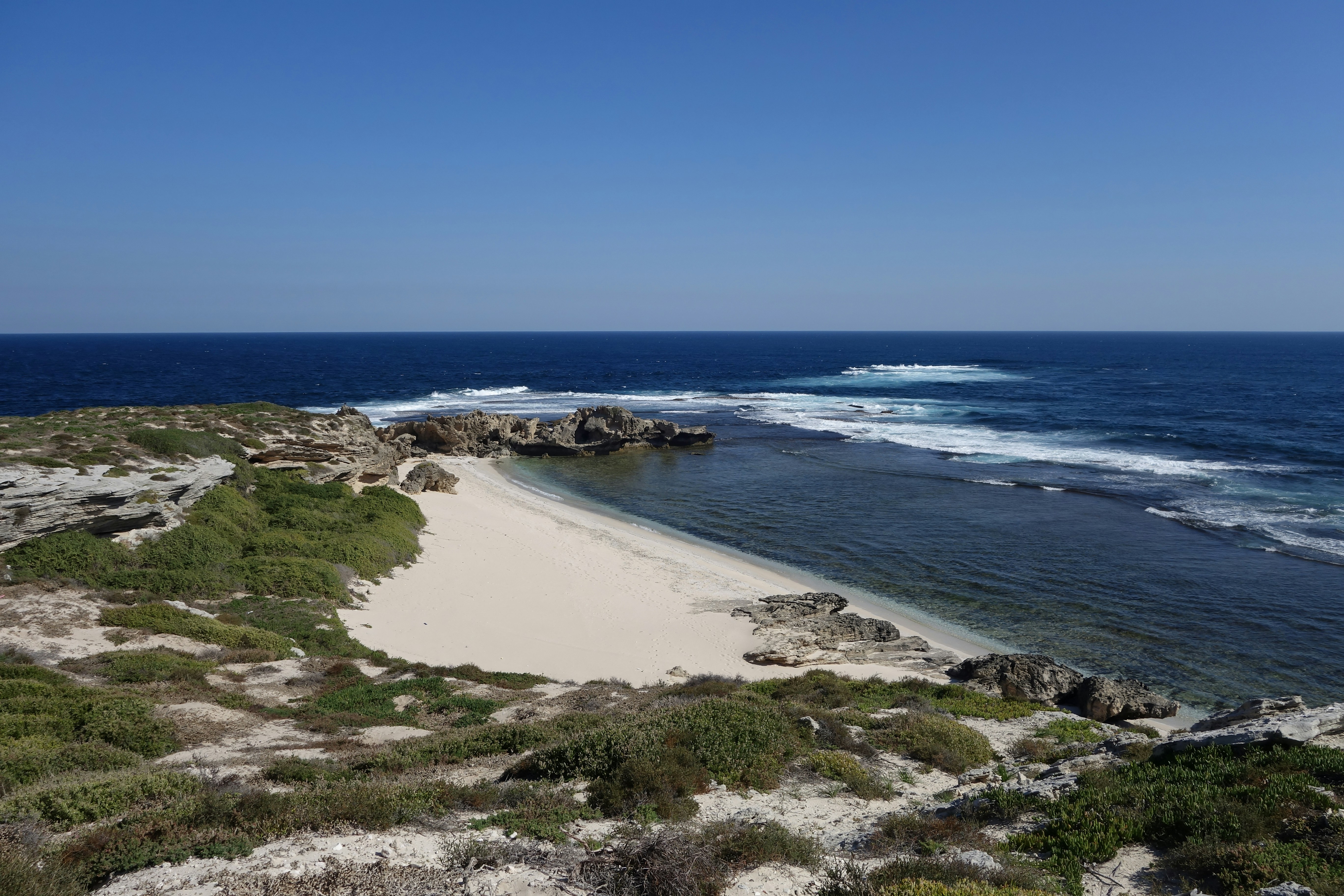 Quiet Cove at Low Tide: A Rugged Shoreline Under a Clear Sky
