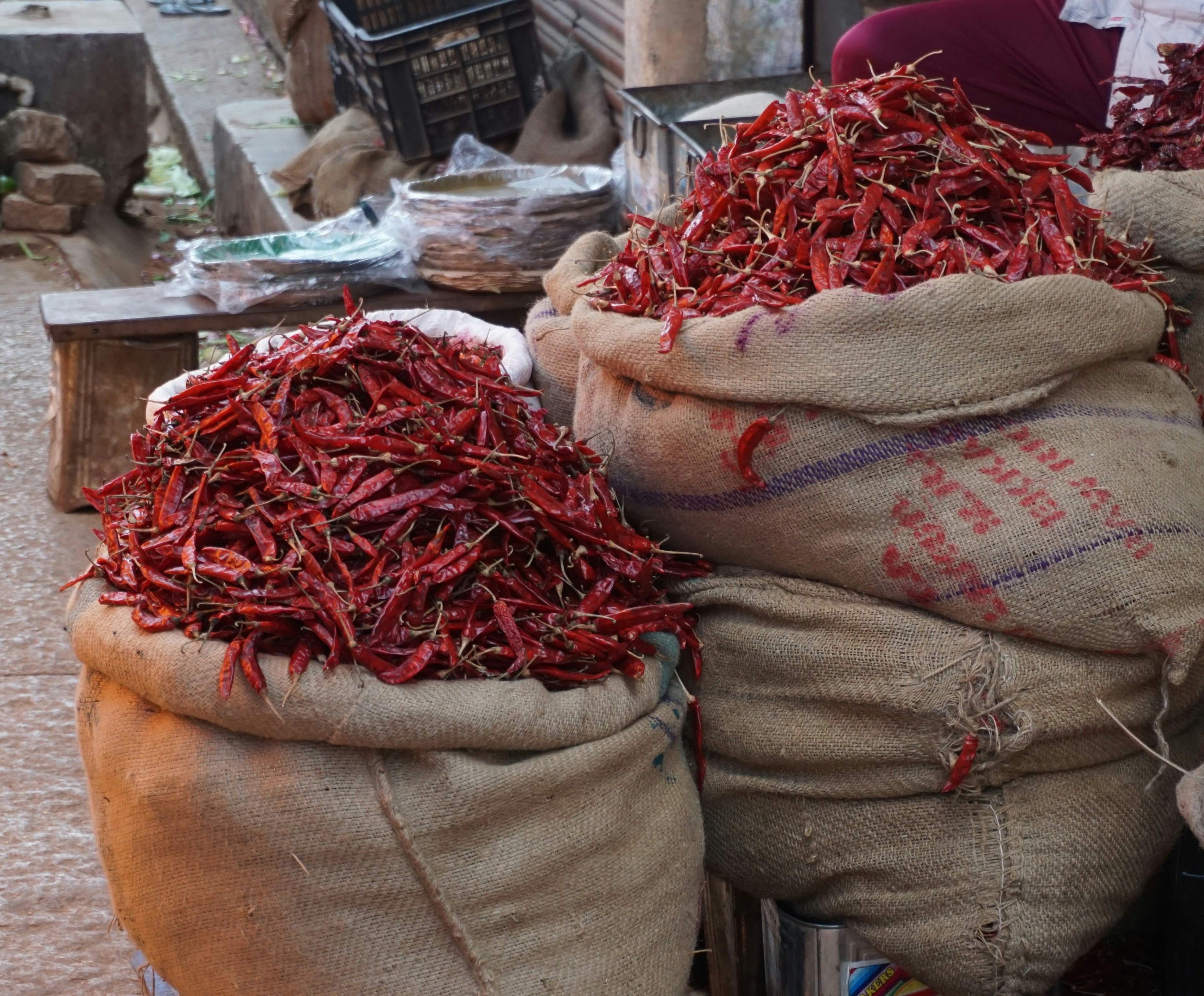 Heap of Red Chilies in Burlap Sacks at a Market