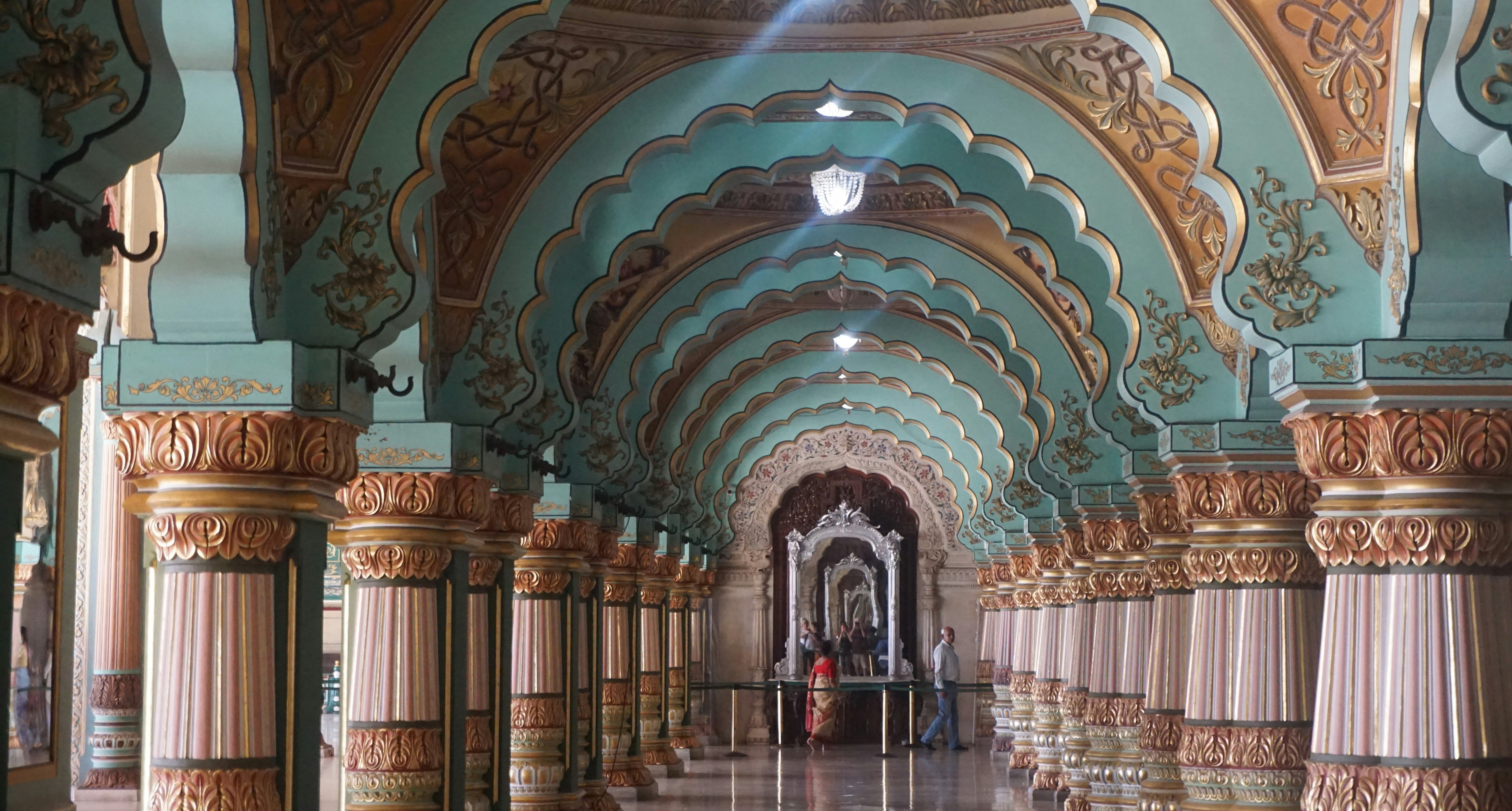 Ceiling Cathedral: Arcaded Corridor Drenched in Teal and Gold