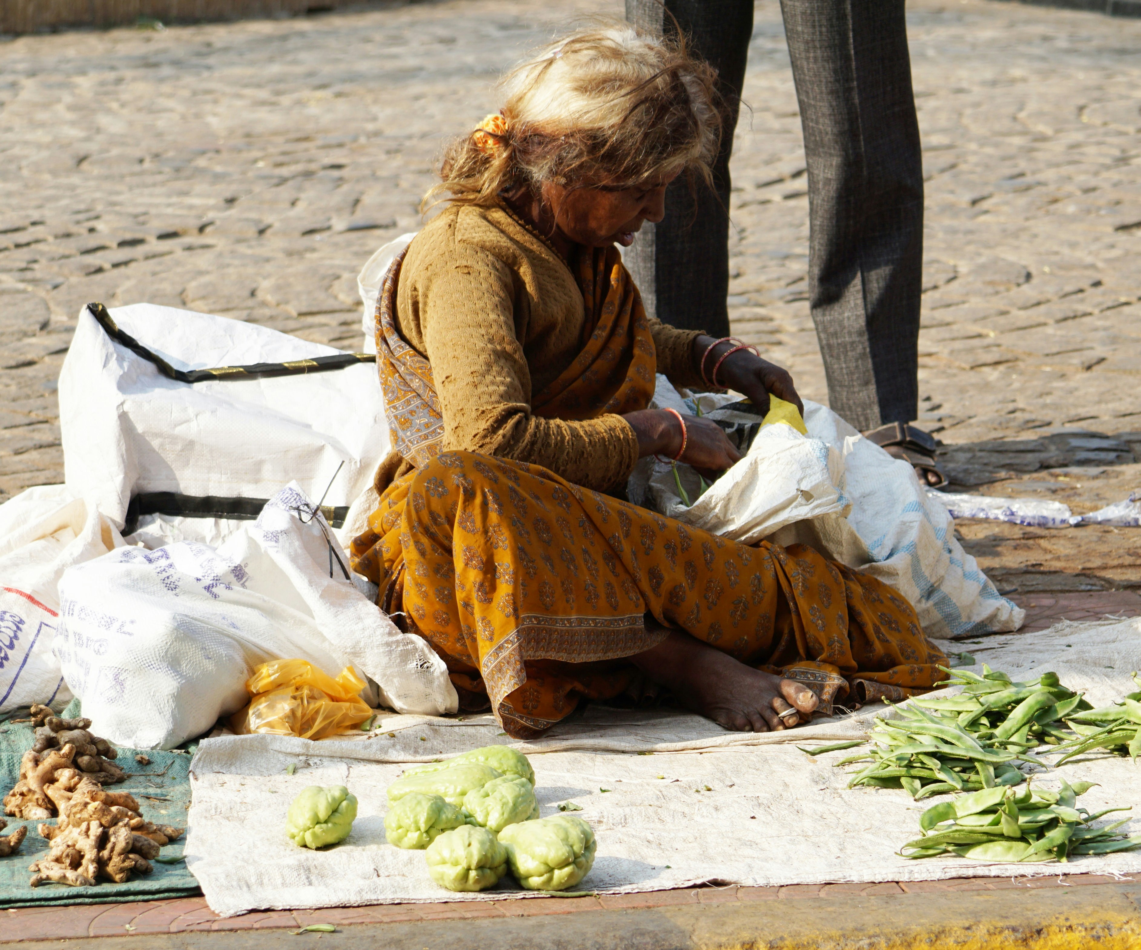 Kneeling Vendor Weaving a Quiet Morning at the Market