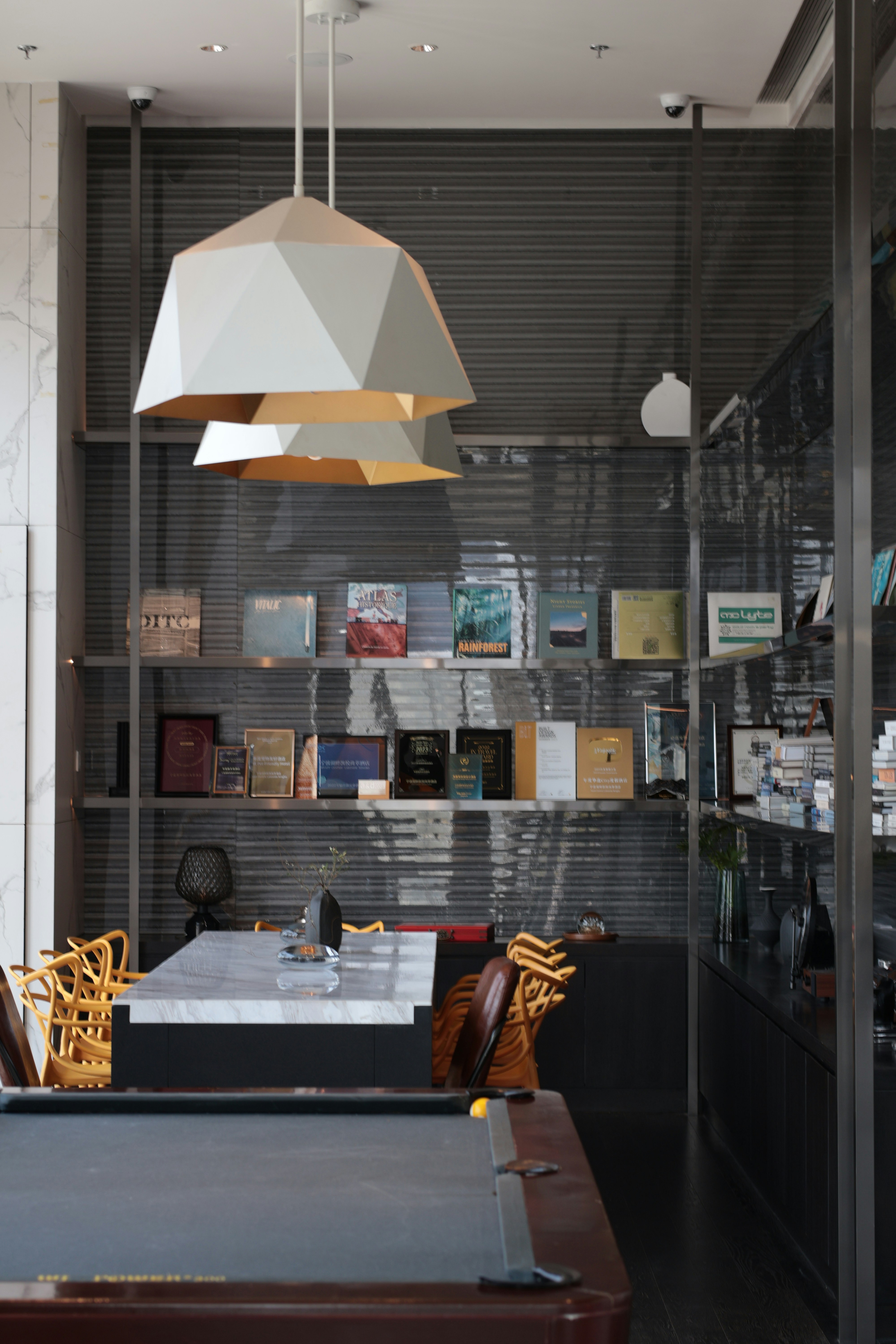 Geometric Lamps Over a Quiet Bookstore Café