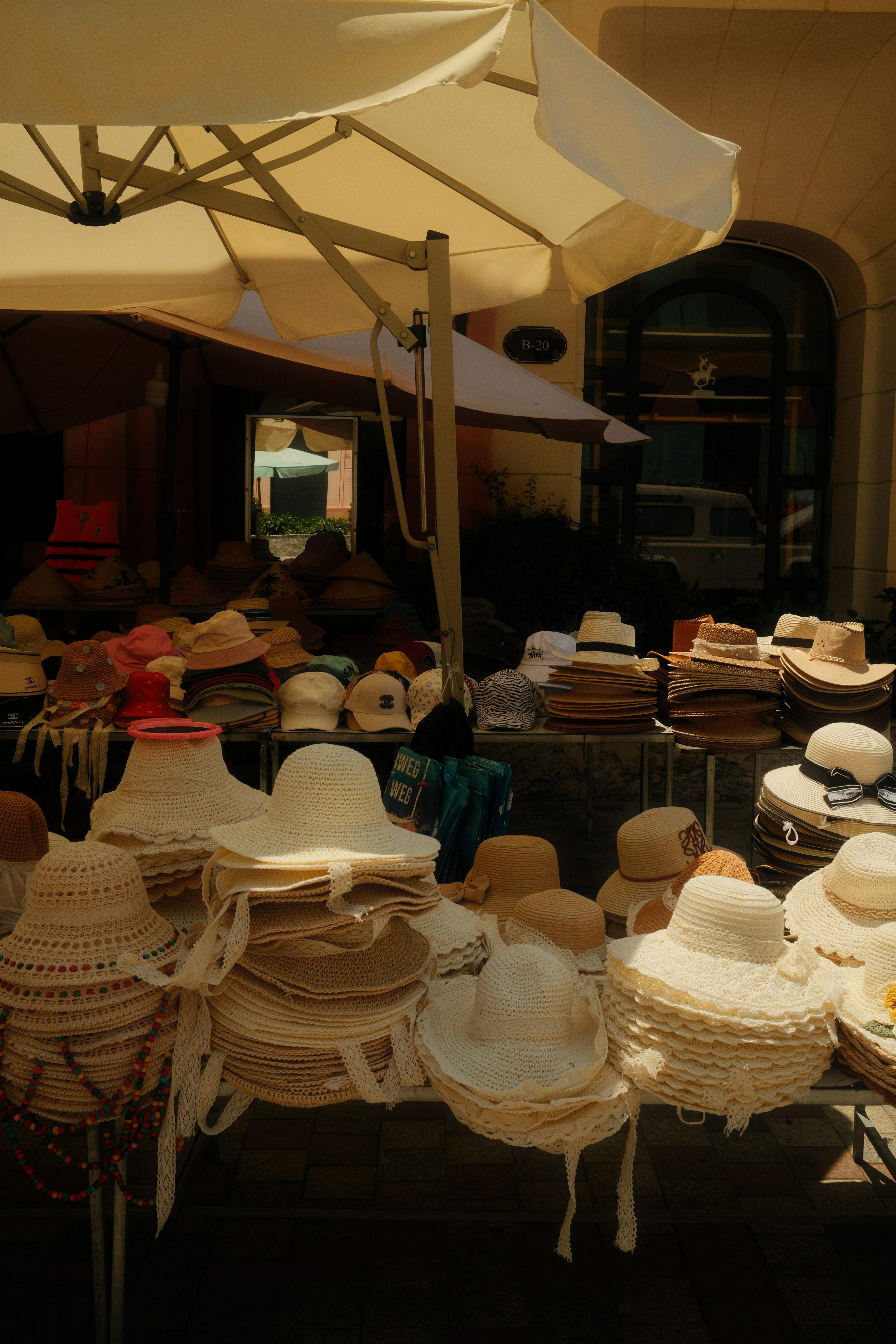 Sunlit Parade of Straw Hats at a Street Market
