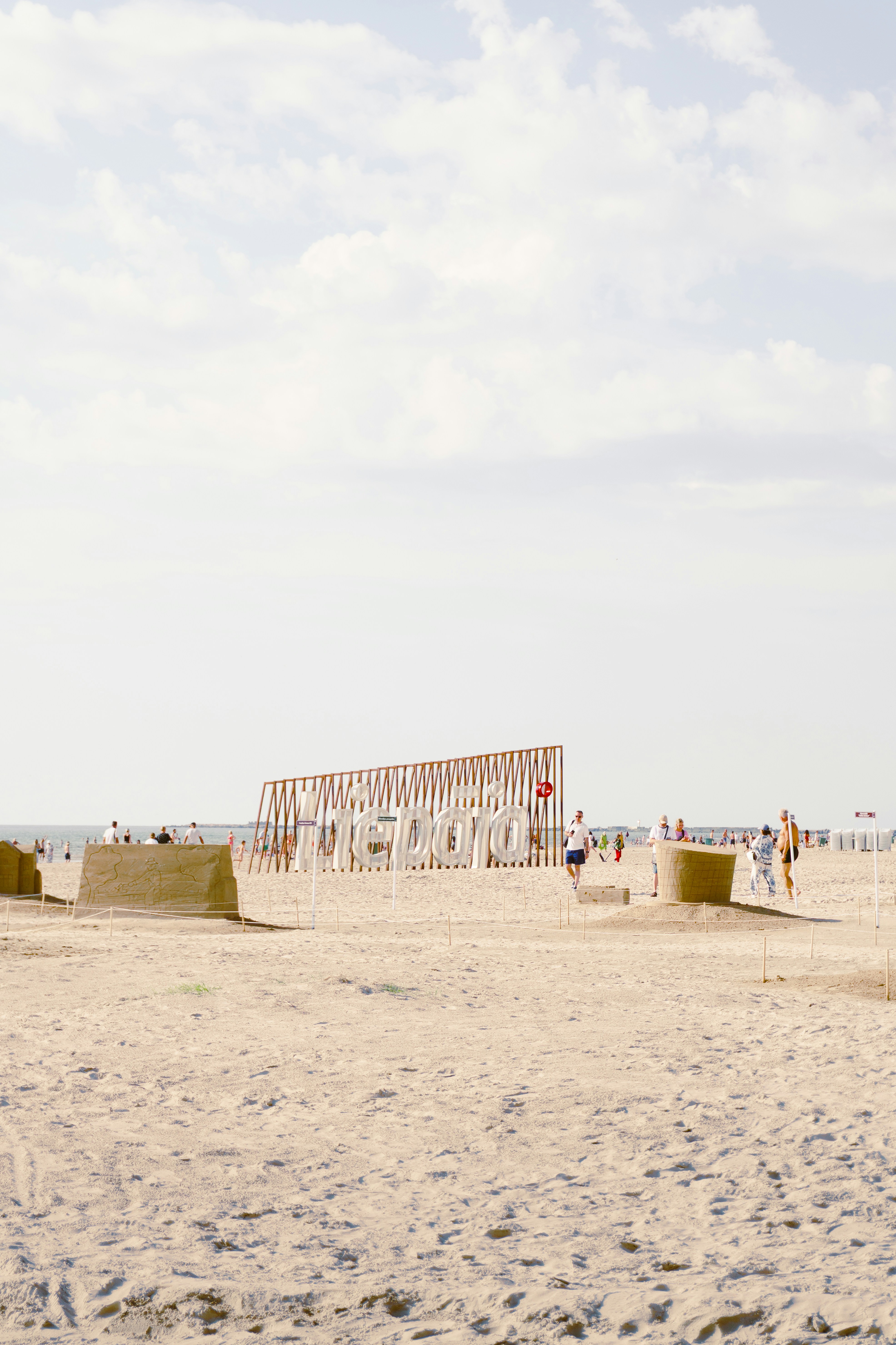 Propped Letters on a Quiet Beach under a Pale Sky