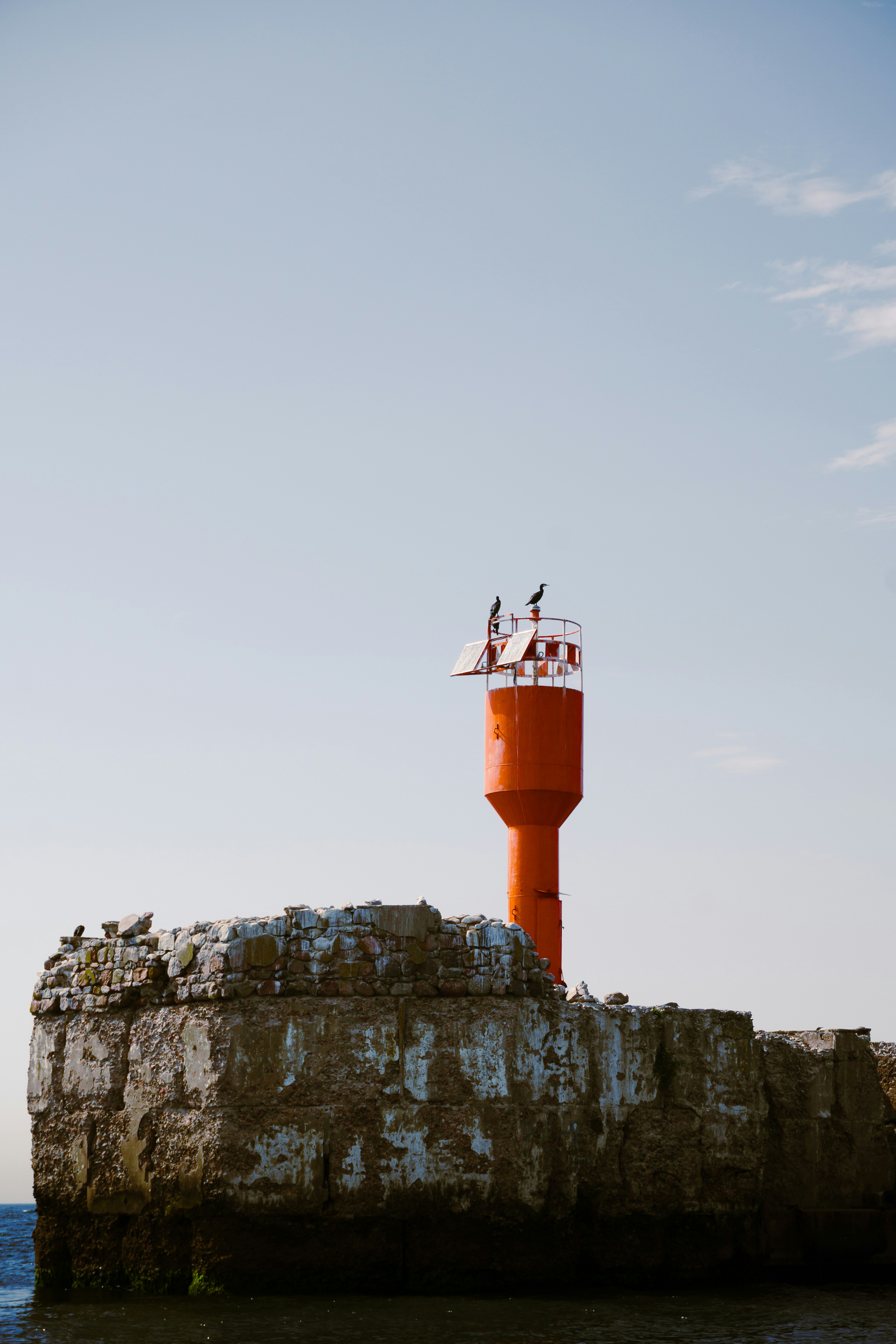 Red Beacon on the Sea Wall: A Maritime Sentinel Under Open Skies