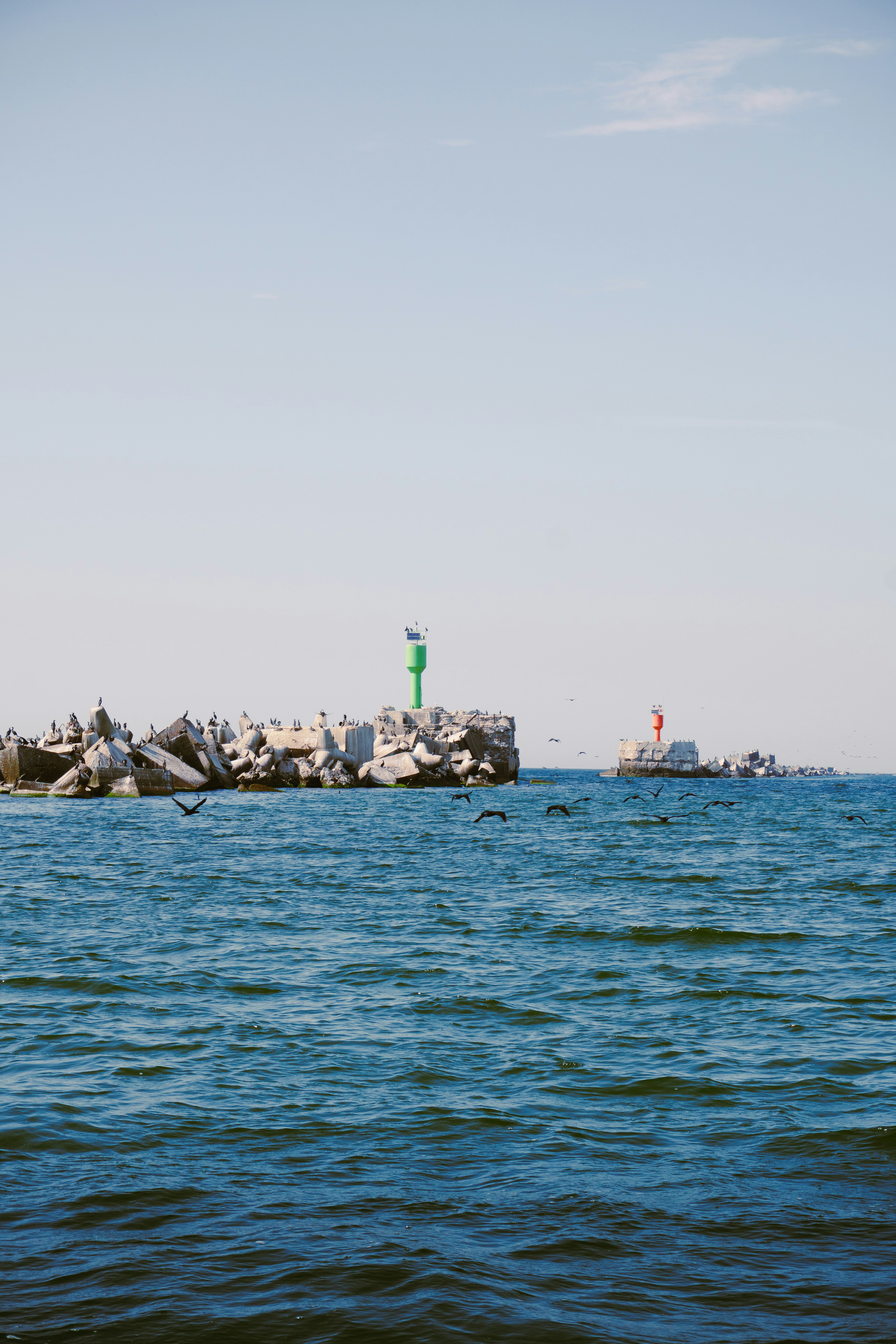 Lighthouse Breakwaters: A Quiet Horizon Over Blue Waters