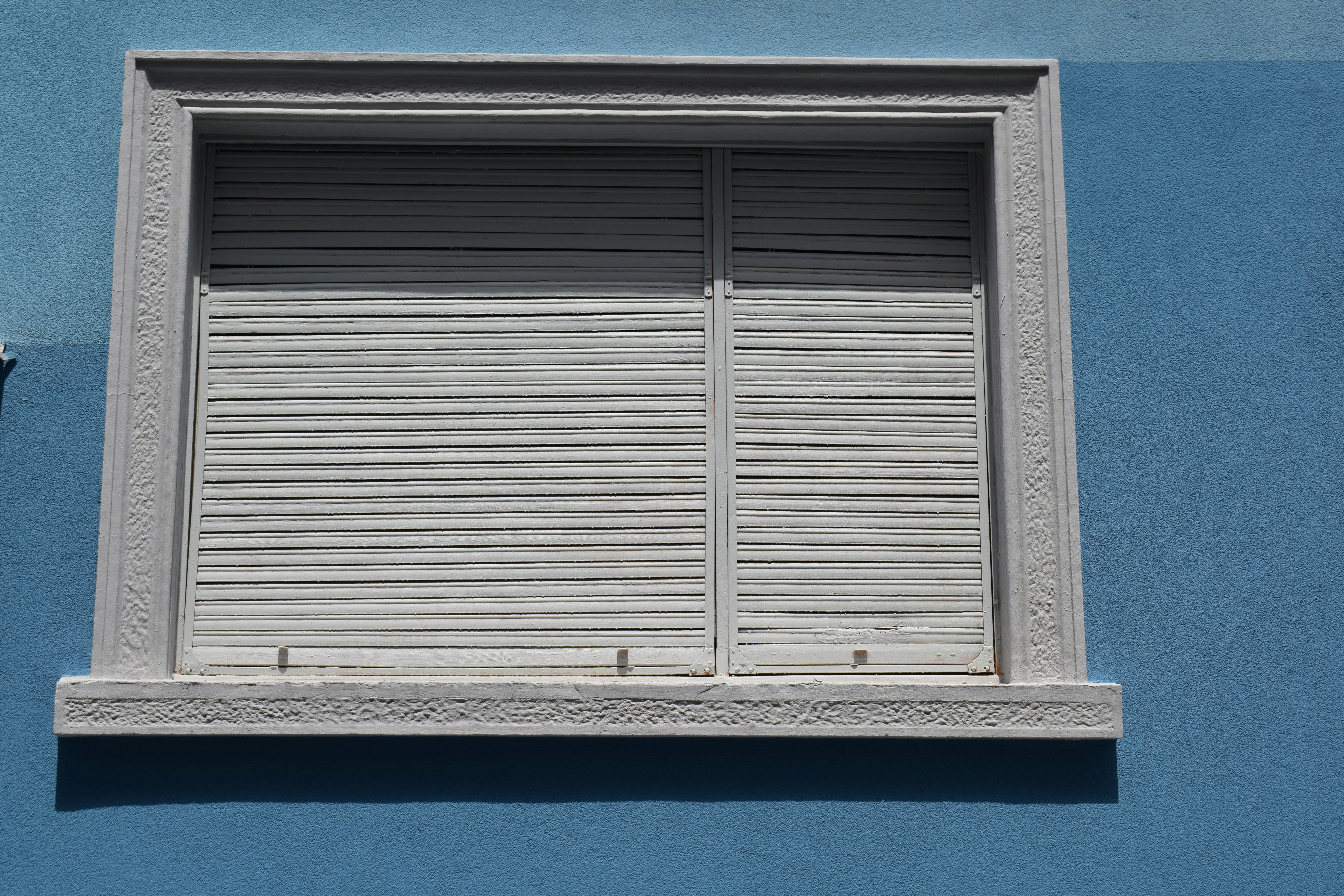 Blue Facade with Shuttered Window