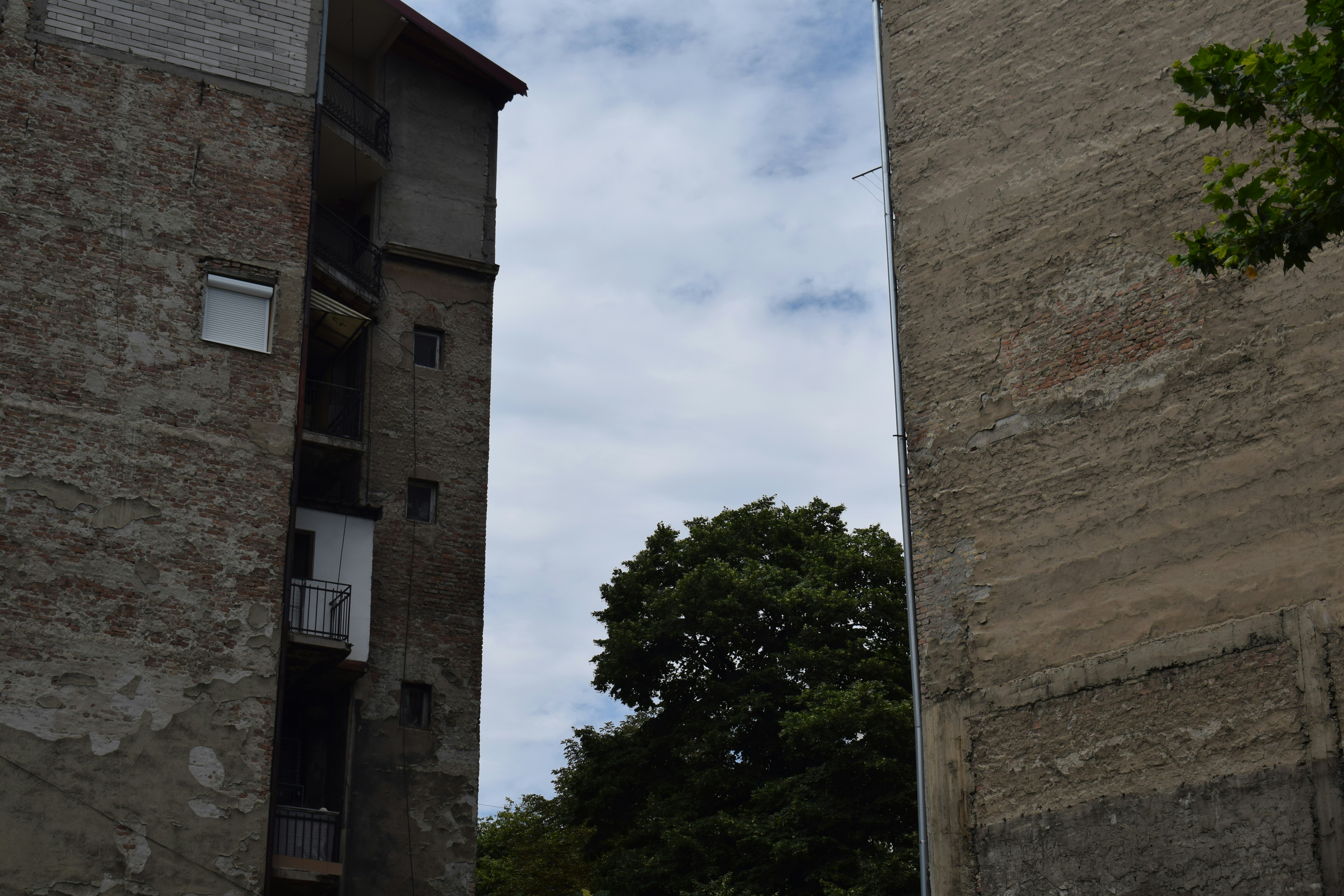 Sky Breaks Between Brick Towers