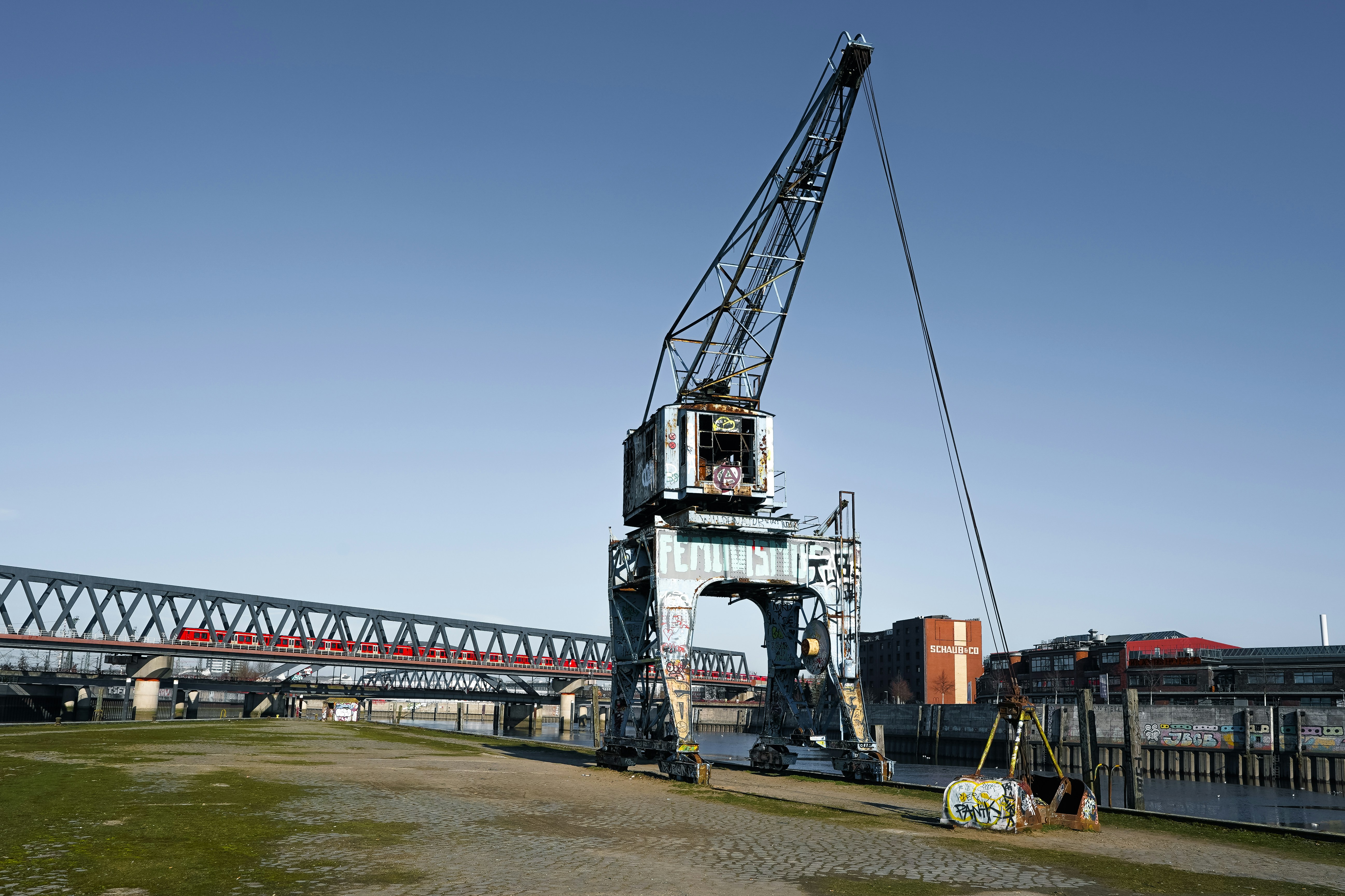 Industrial Giant: The Crane Reaches Over the Tidal Shore