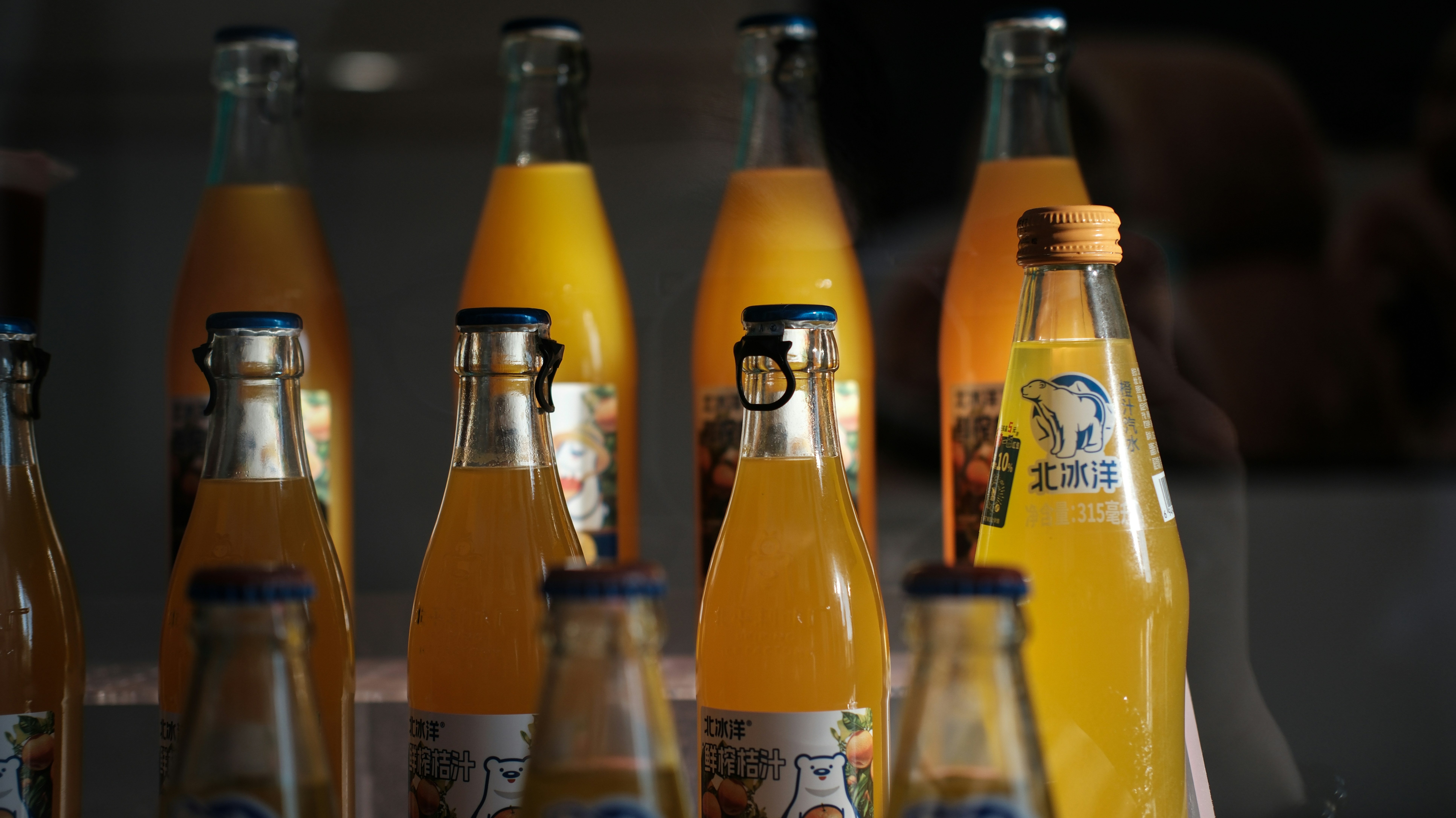 Orange Glasses, Quiet Bottles: A Still Life of Bottled Brights