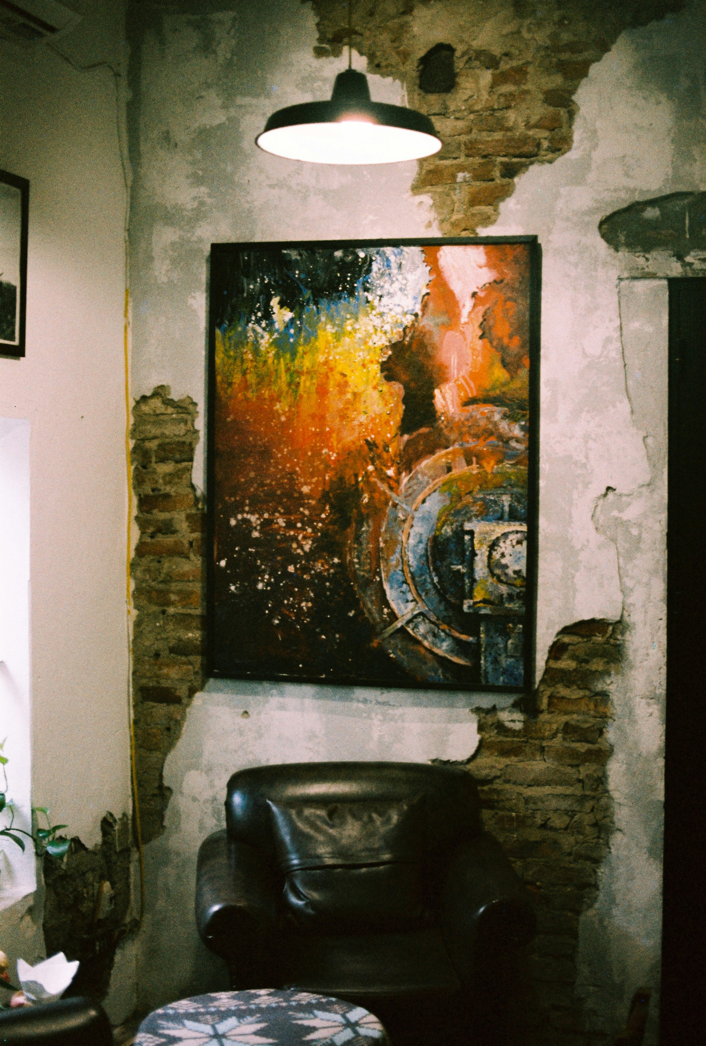 Industrial Loft Portrait: Abstract Painting Anchors a Cozy Corner