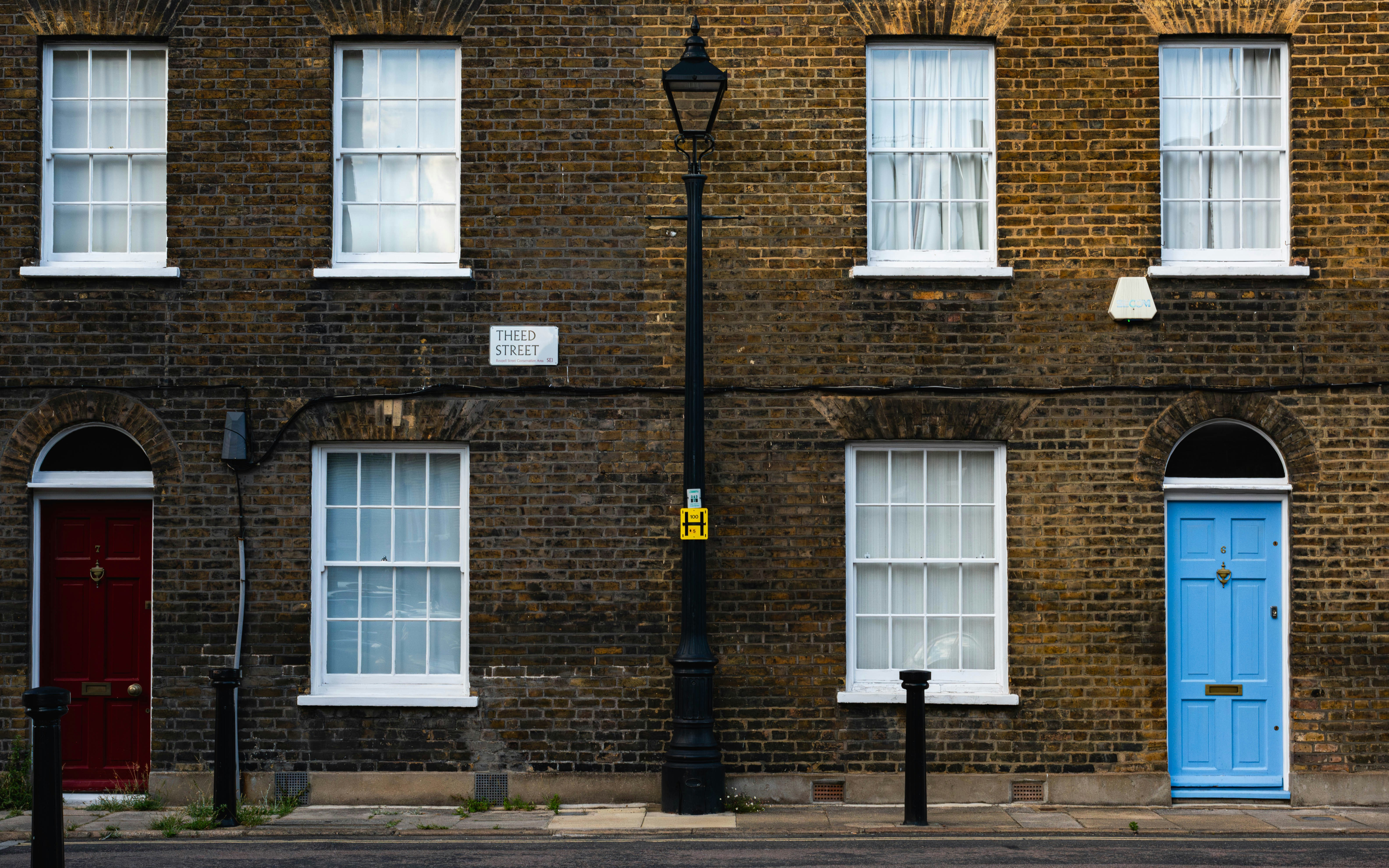 Colorful Doors on a Brick Terrace: A Tranquil City Facade