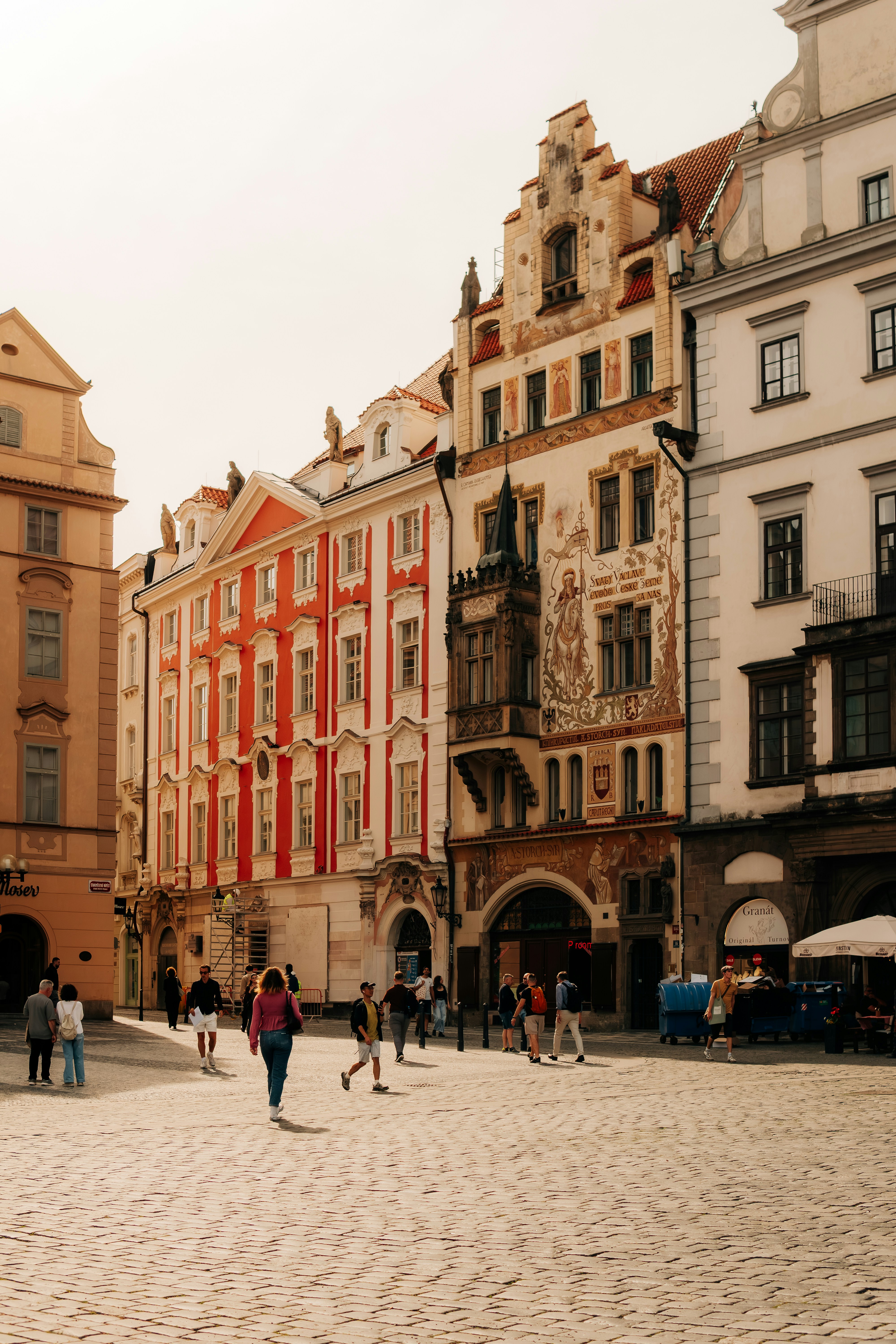 Cobbled Clockwork: A Sunlit Street of Colorful Facades