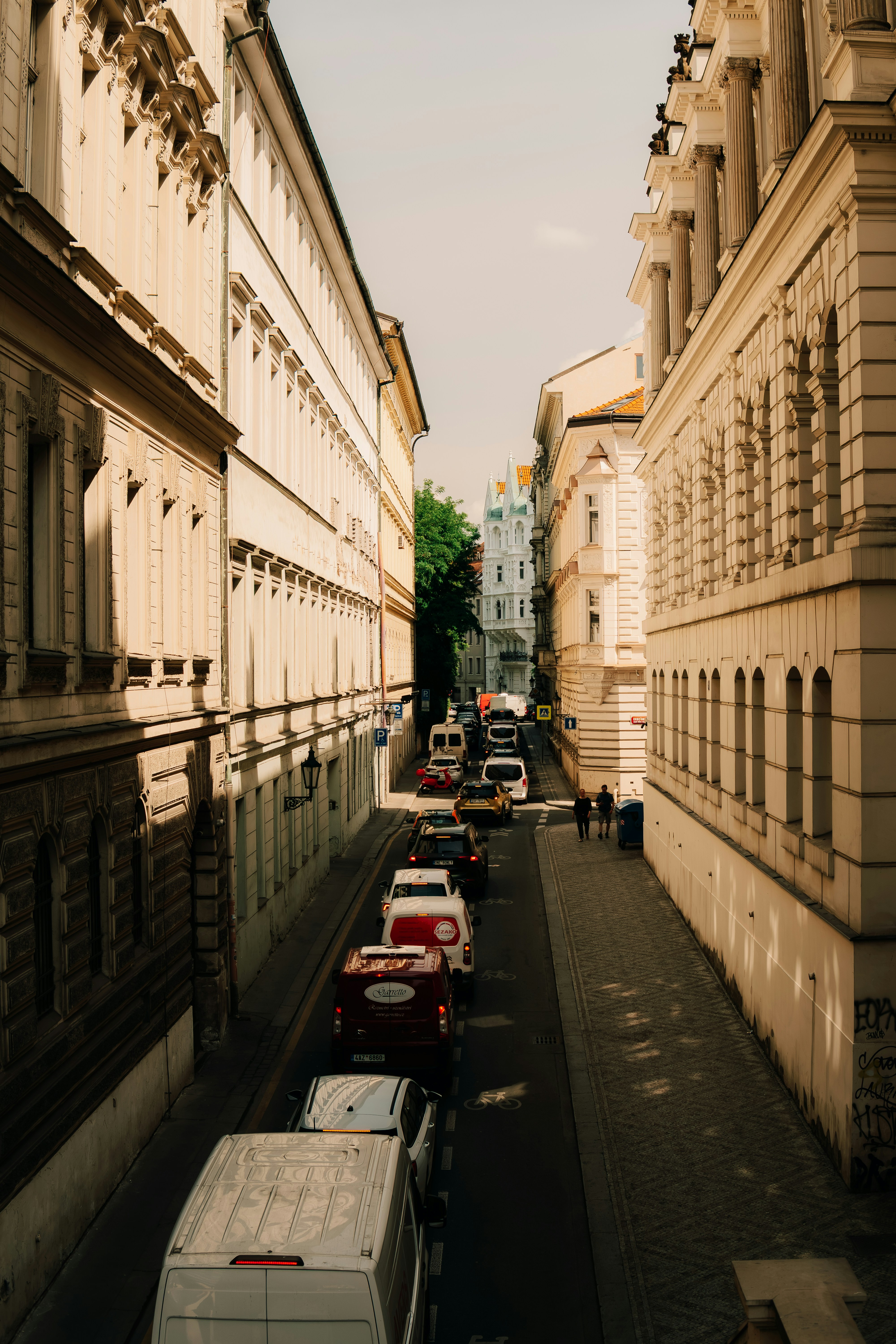 Street in Golden Hour: Lines, Cast Shadows, and a Queue of Cars