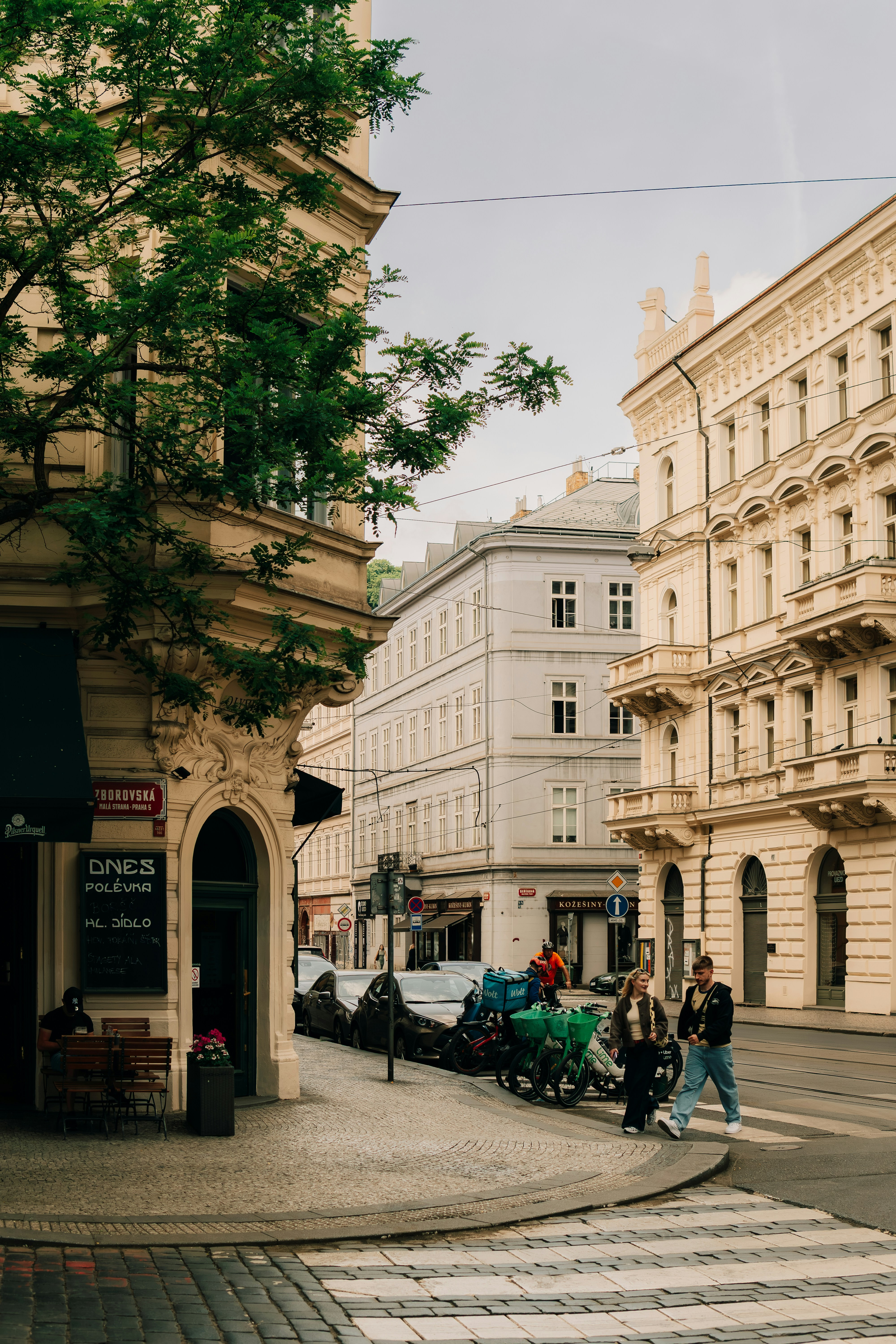 A Corner of Calm: Pedestrians and Pastel Facades on a European Street