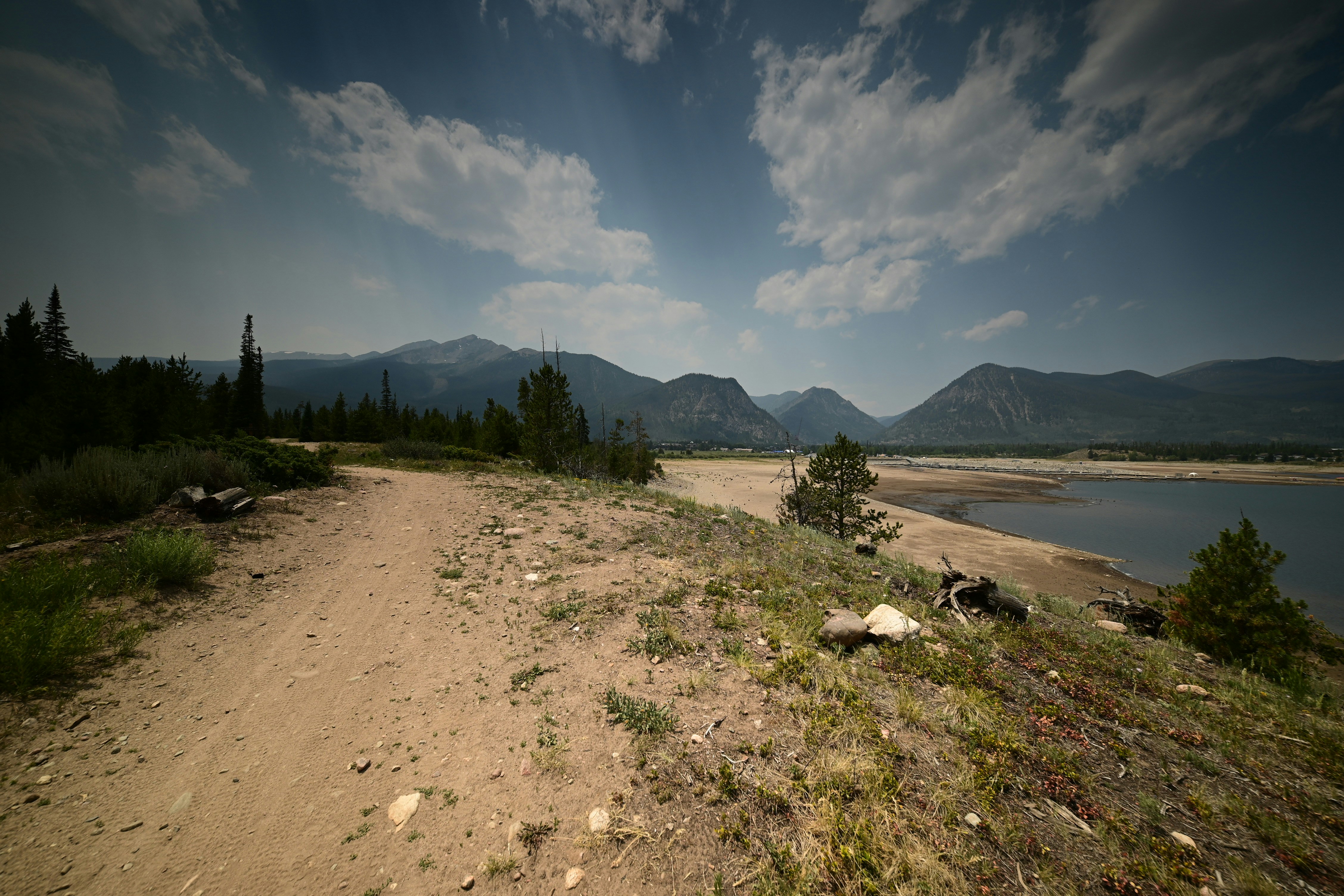 Ridge Walk Toward Distant Peaks Under a Quiet Sky