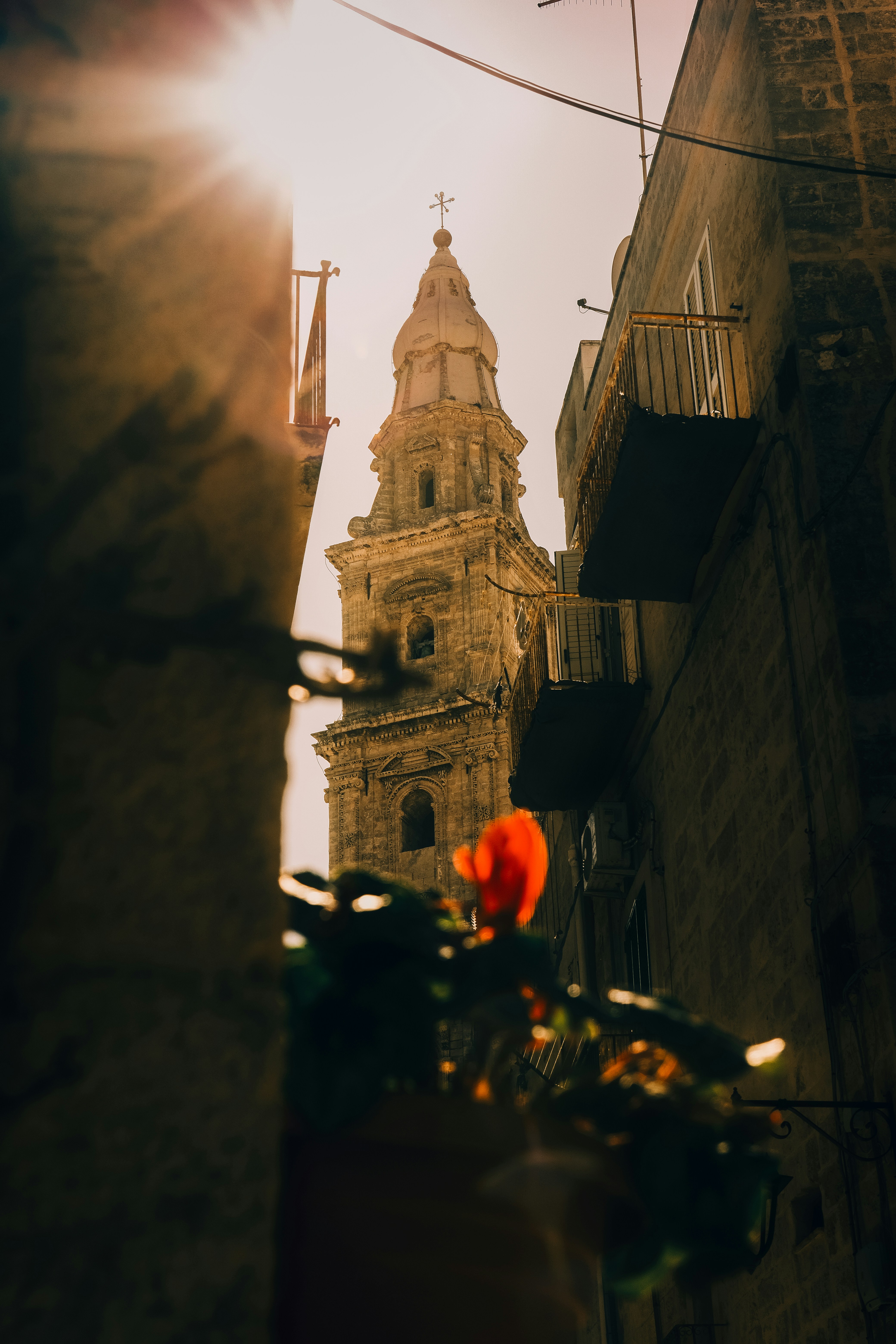 Sunlit Bell Tower Framed by Narrow Calle, Ancient Walls in Twilight